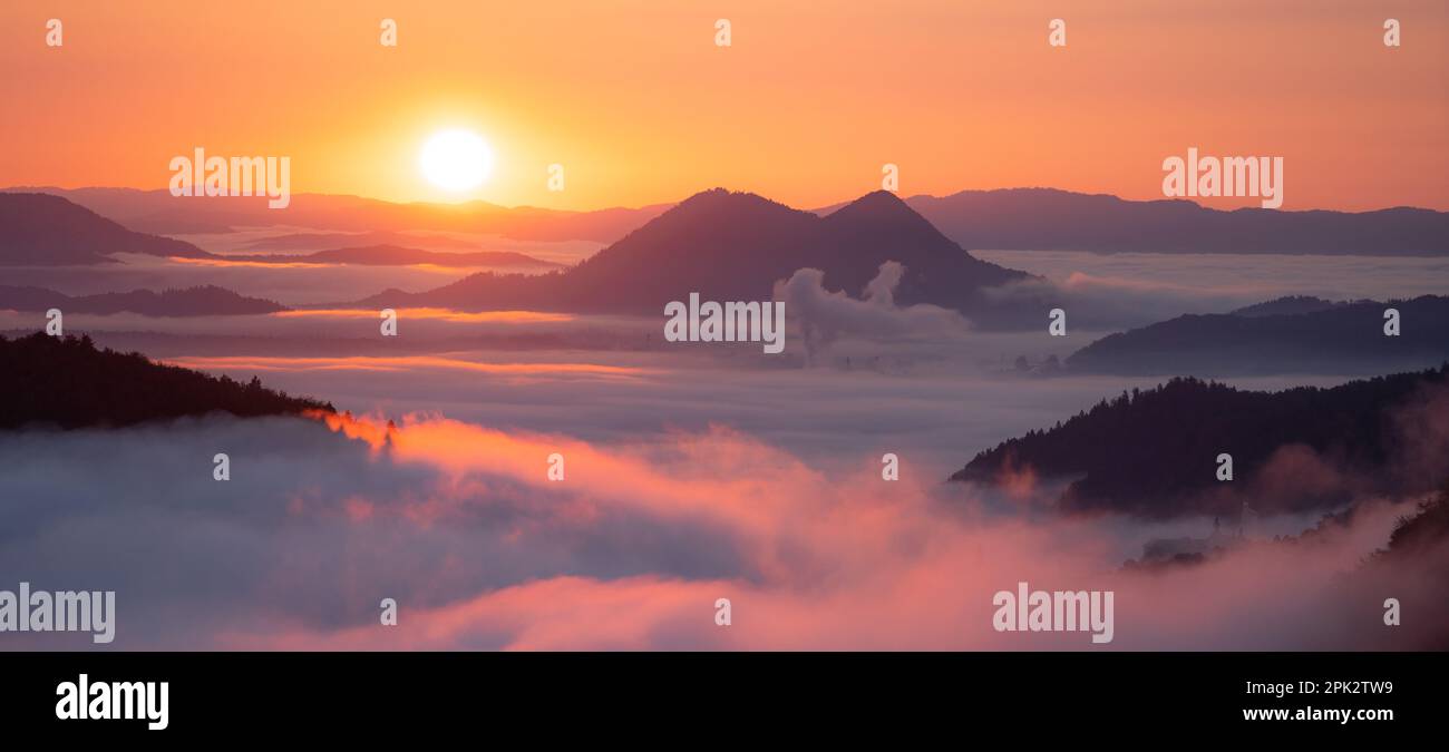An awe-inspiring view of the sun rising over the majestic mountains in ...