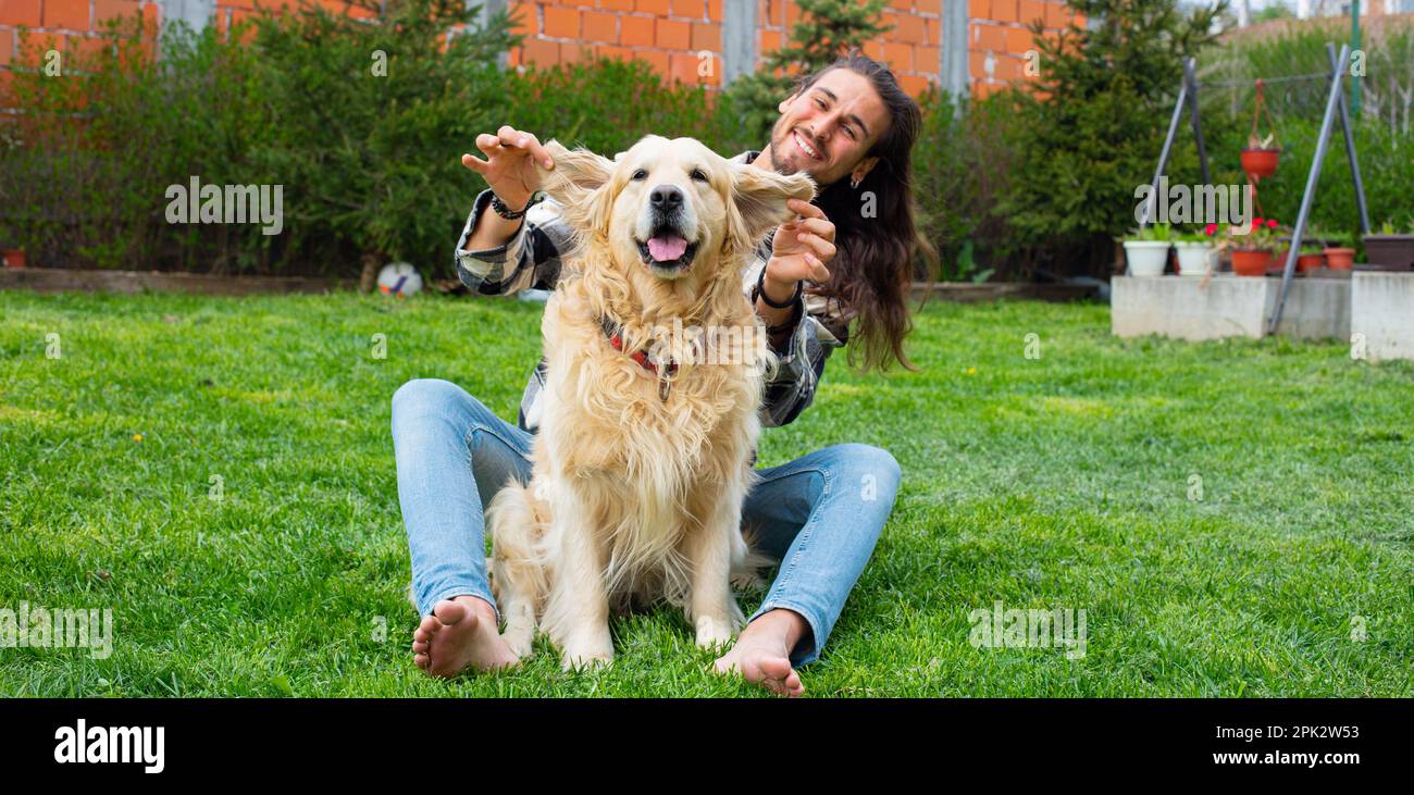 Golden retriever and owner Stock Photo - Alamy