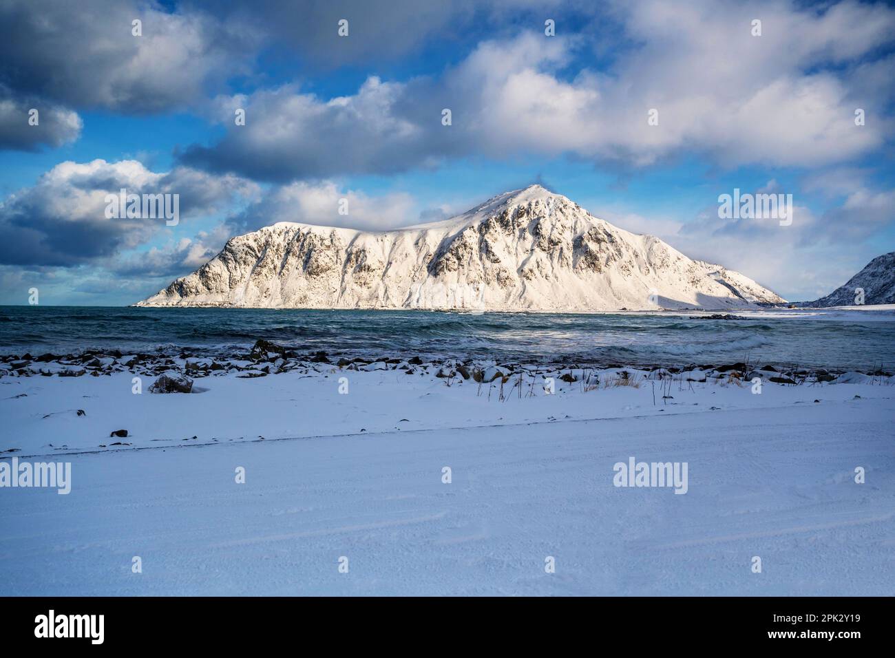 Snowy landscape at arctic Skagsanden beach. Rocky mountain, sunny ...