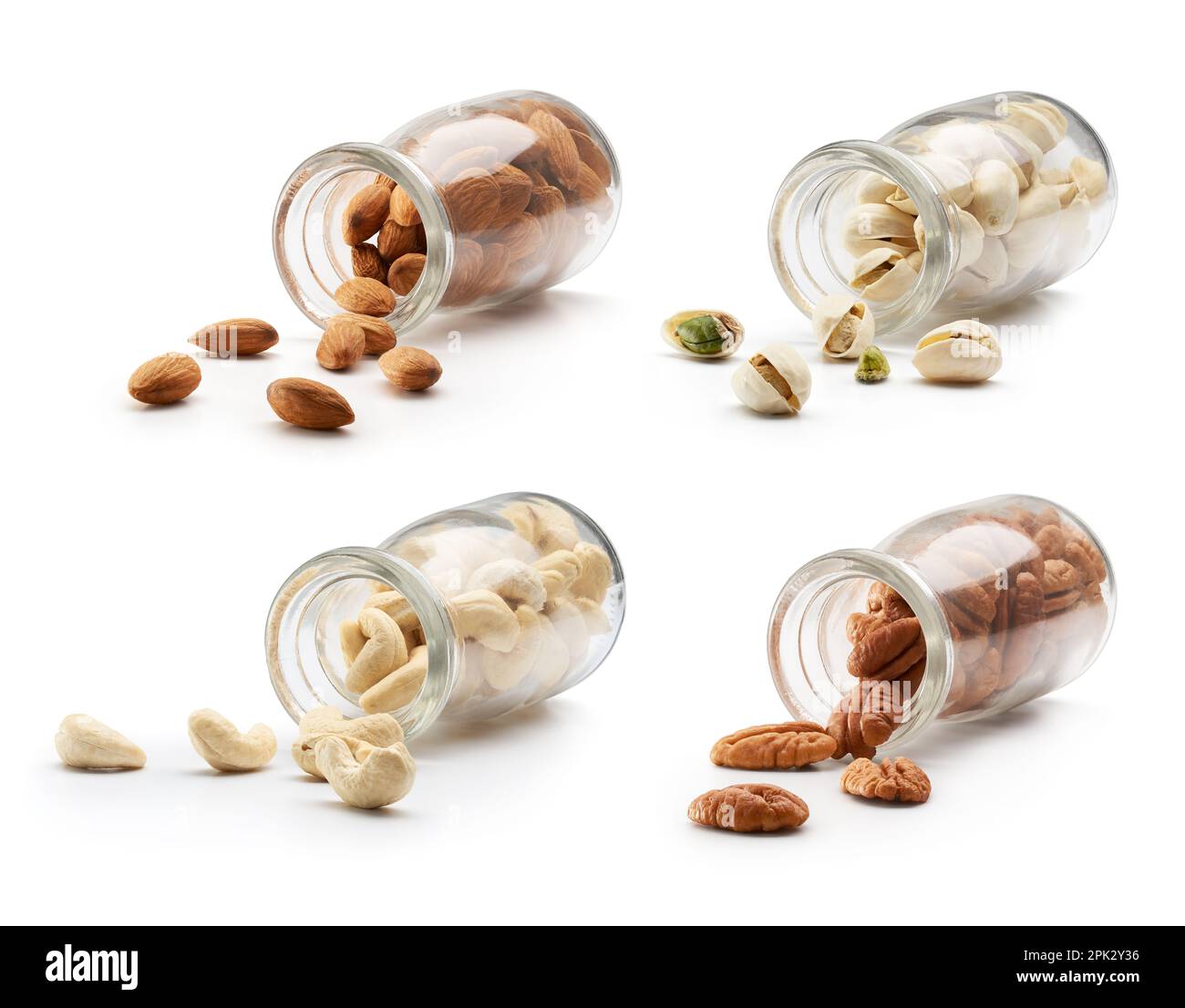 Nuts pouring out from bottle over white background Stock Photo - Alamy