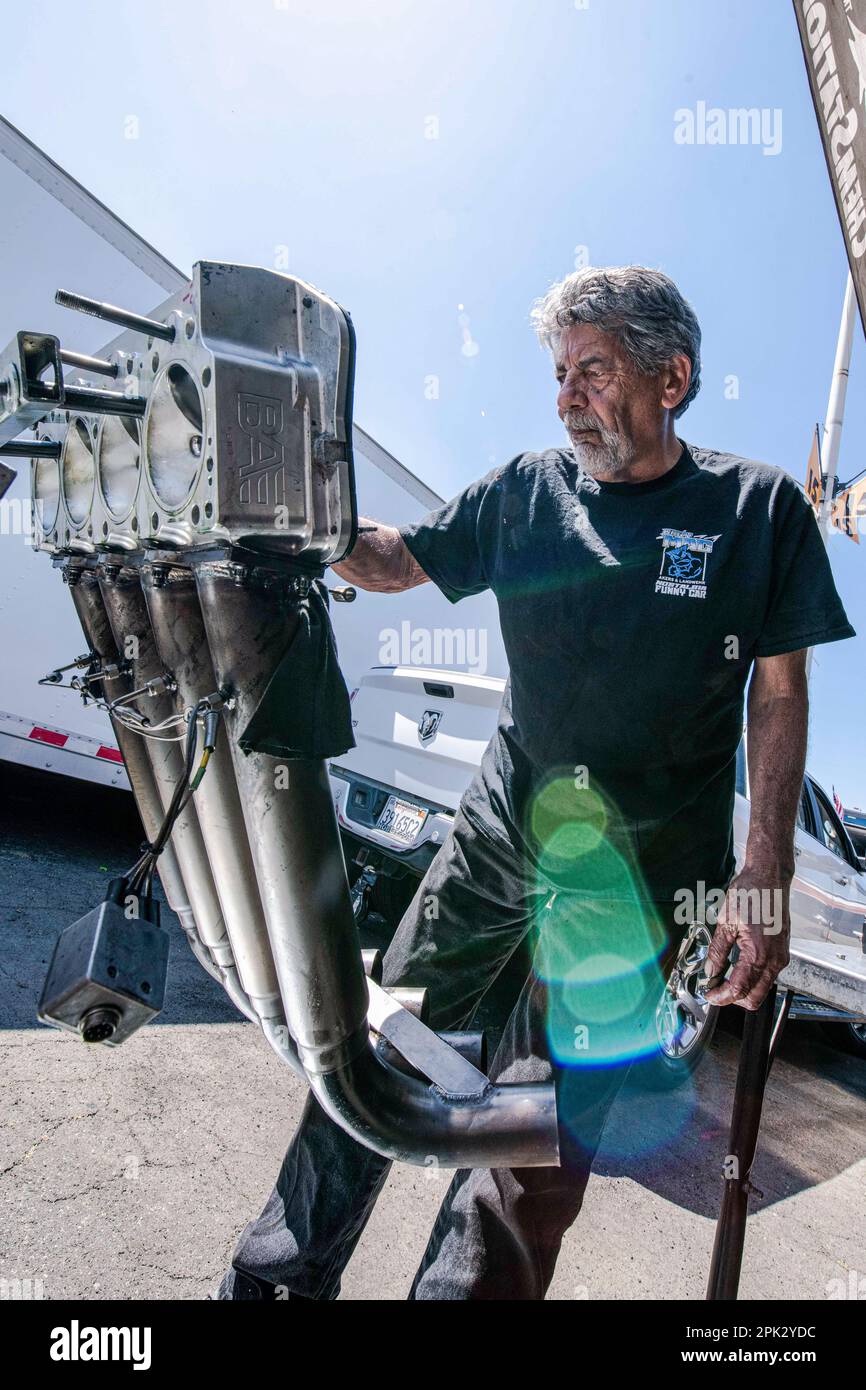 A crewchief from Team Mac Attack, lubes up part of the engine in ...