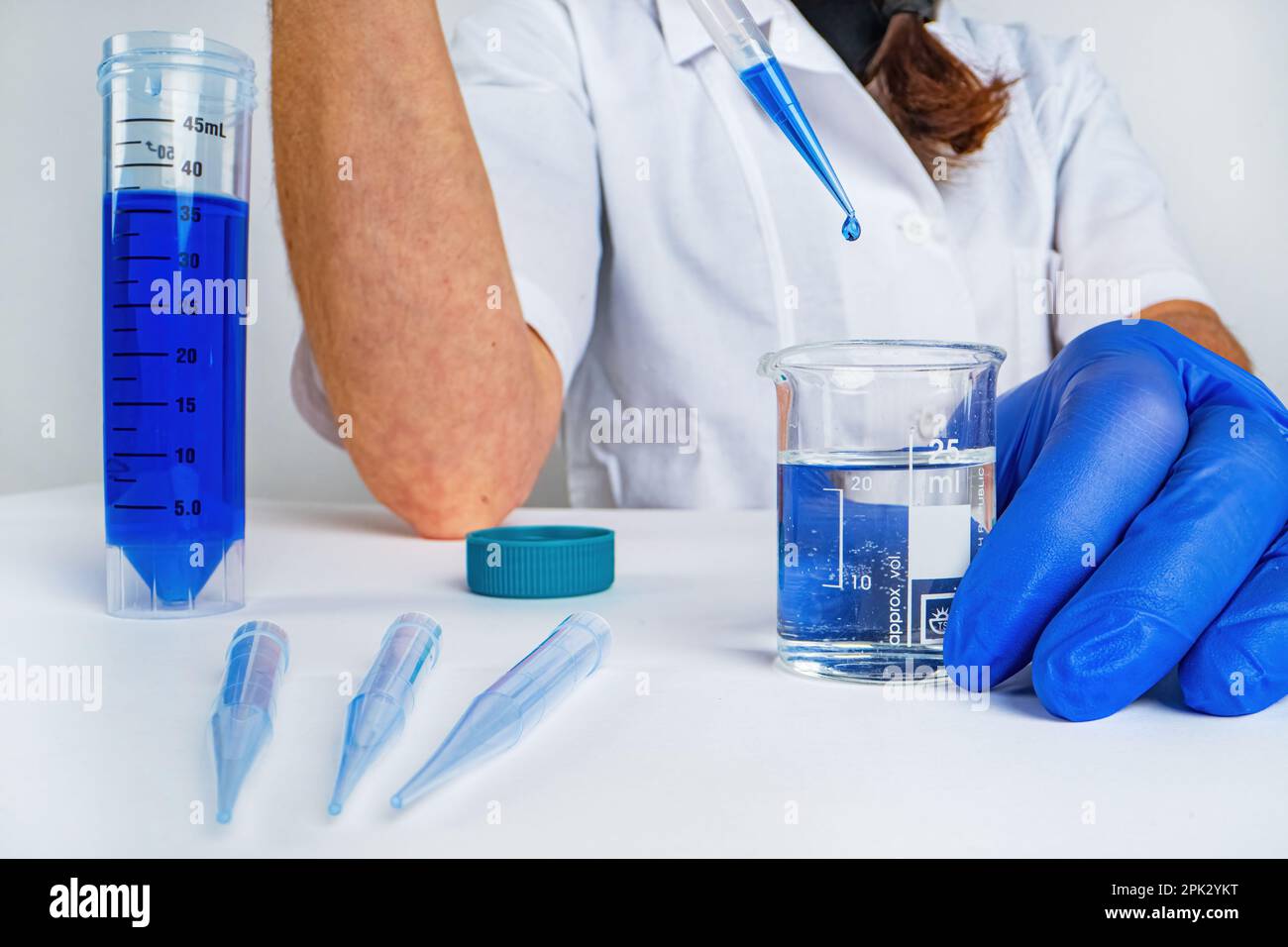 Scientist doctor pipetting samples in the lab with many scientific ...