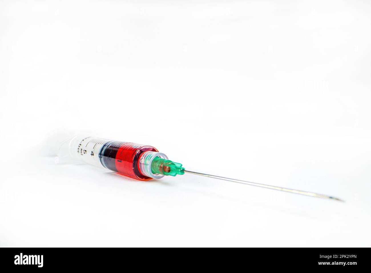 Injection syringe in detail with blood on white background Stock Photo ...