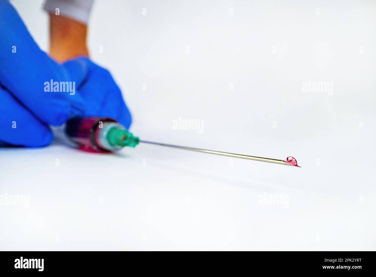 Injection syringe in detailed look with blood on white background Stock ...
