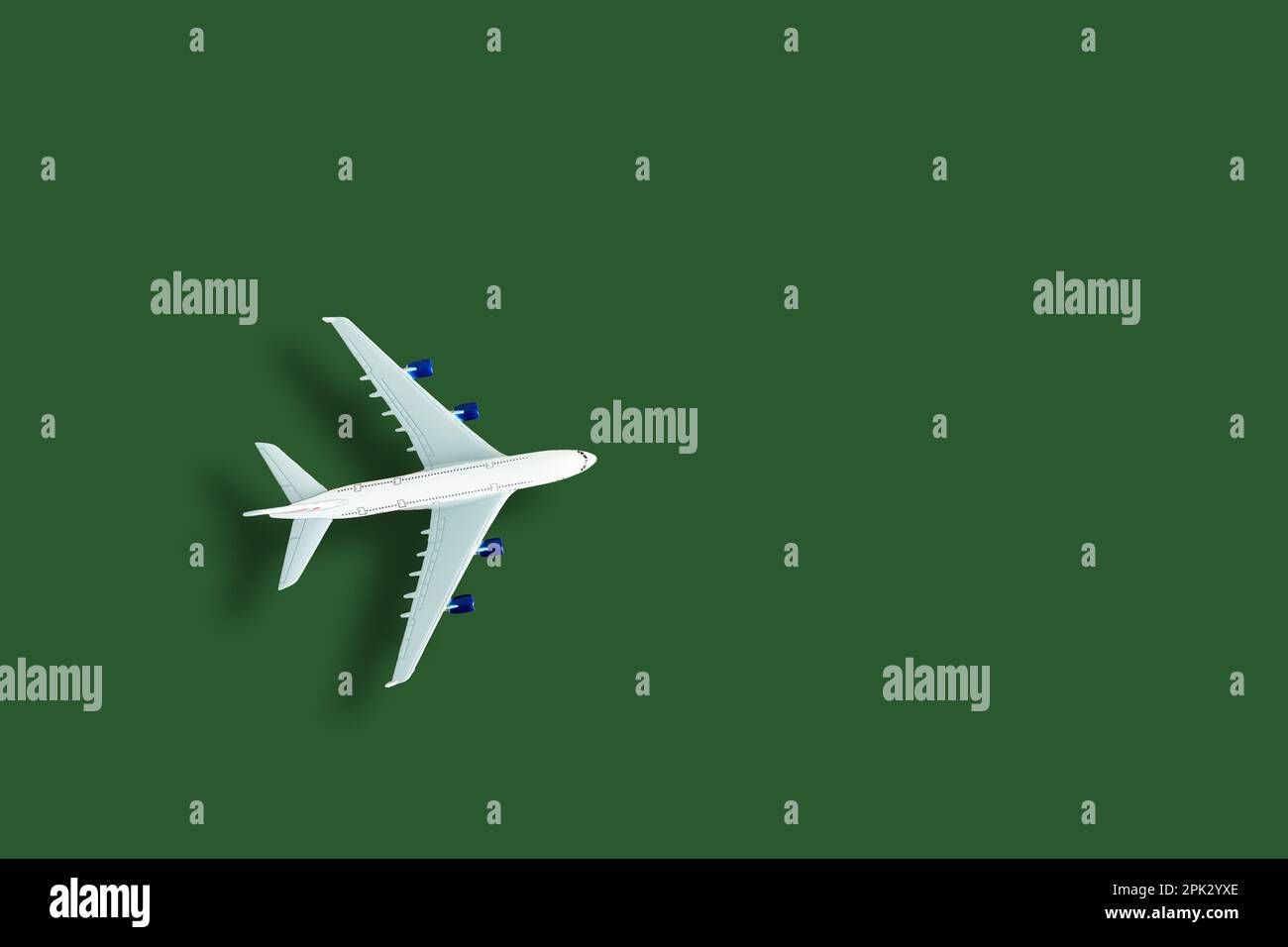 Airplane model. White plane on green background. Travel vacation ...