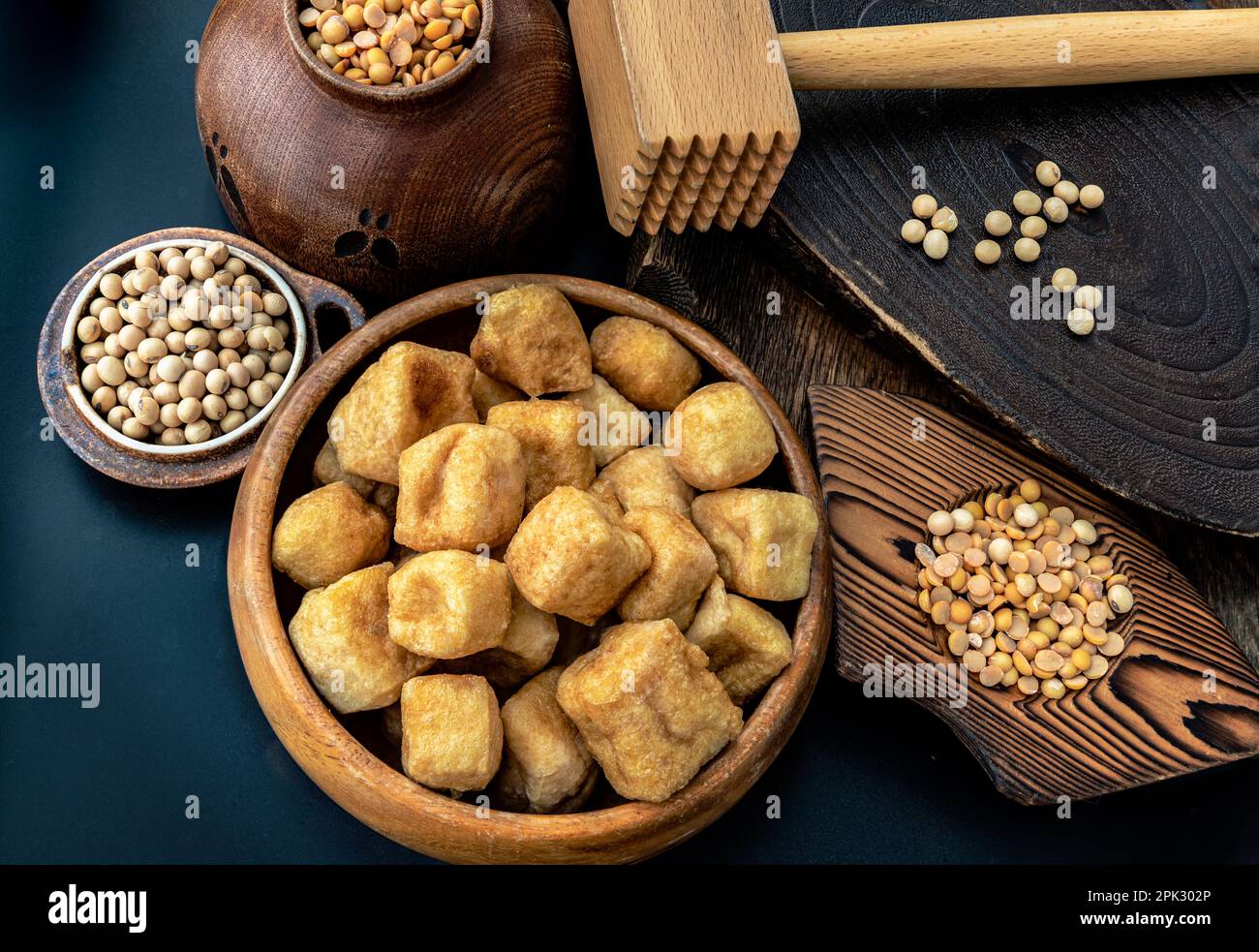 Brown fried tofu puffs or Deep Fried Tofu in wooden bowl and grains ...
