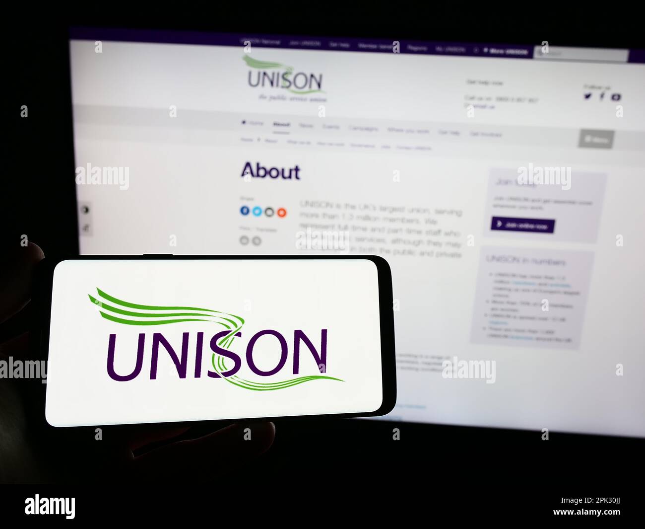 Person holding smartphone with logo of British trade union UNISON on ...