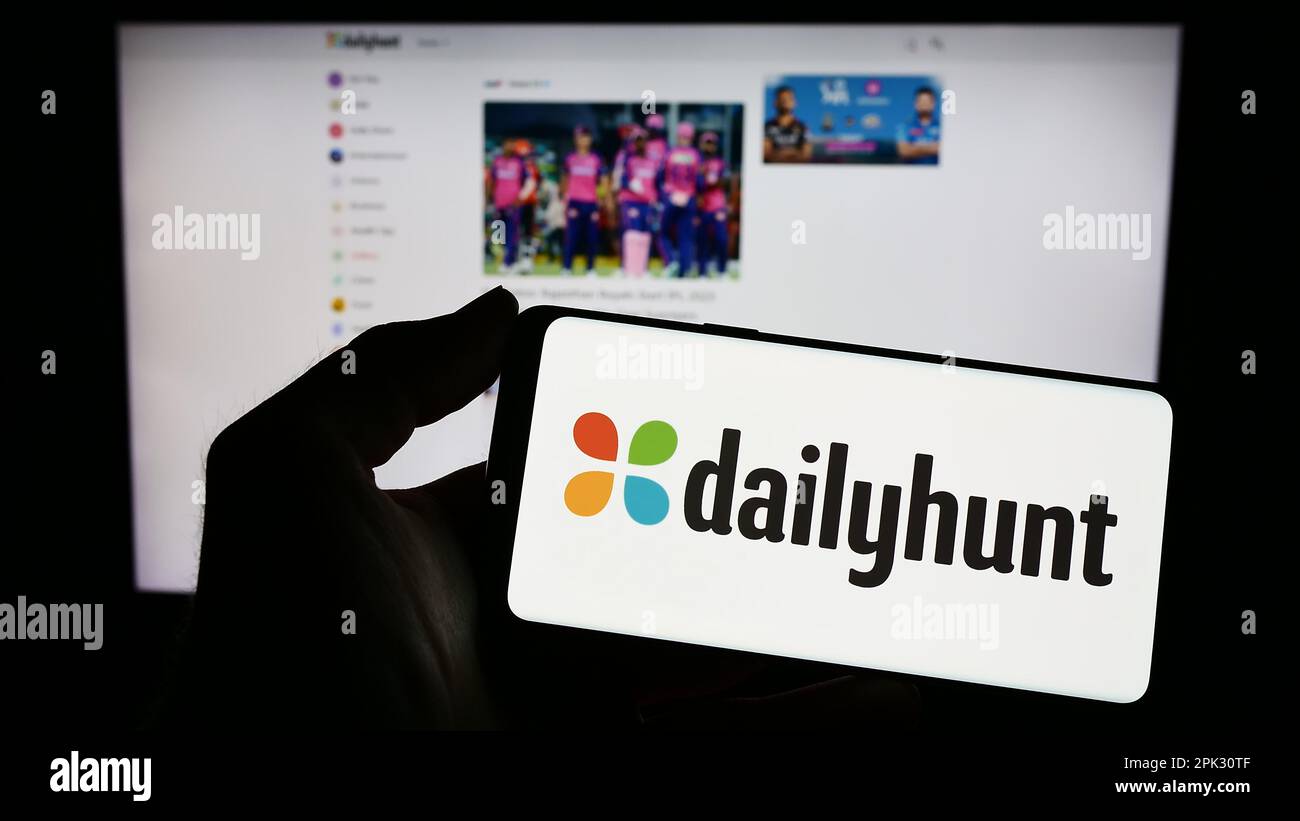 Person holding mobile phone with logo of Indian news aggregation ...