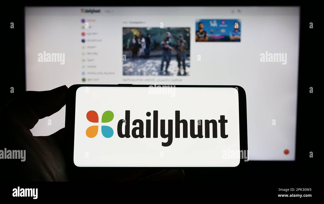 Person holding cellphone with logo of Indian news aggregation platform ...