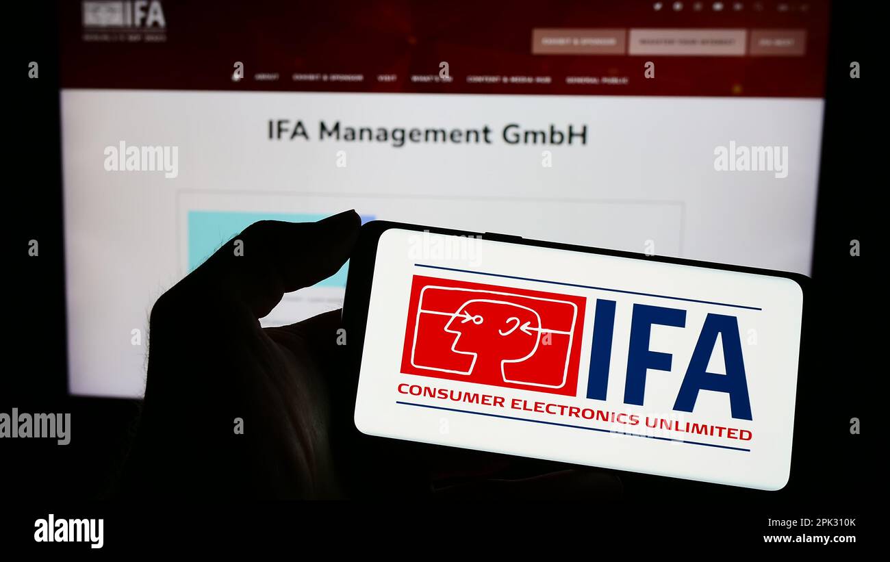 Person holding mobile phone with logo of Internationale Funkausstellung ...