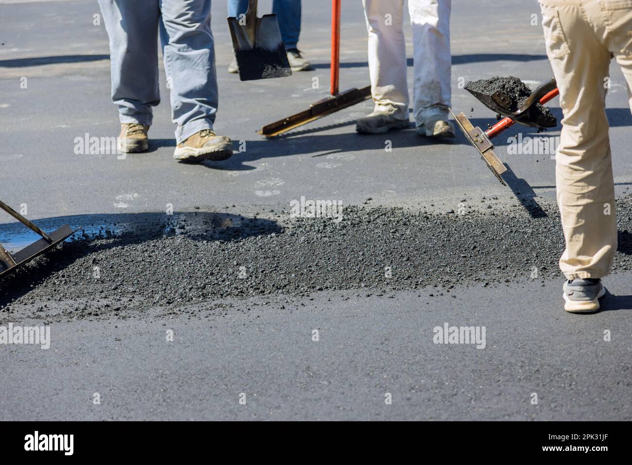 Construction worker laying new asphalt roads as part process of ...