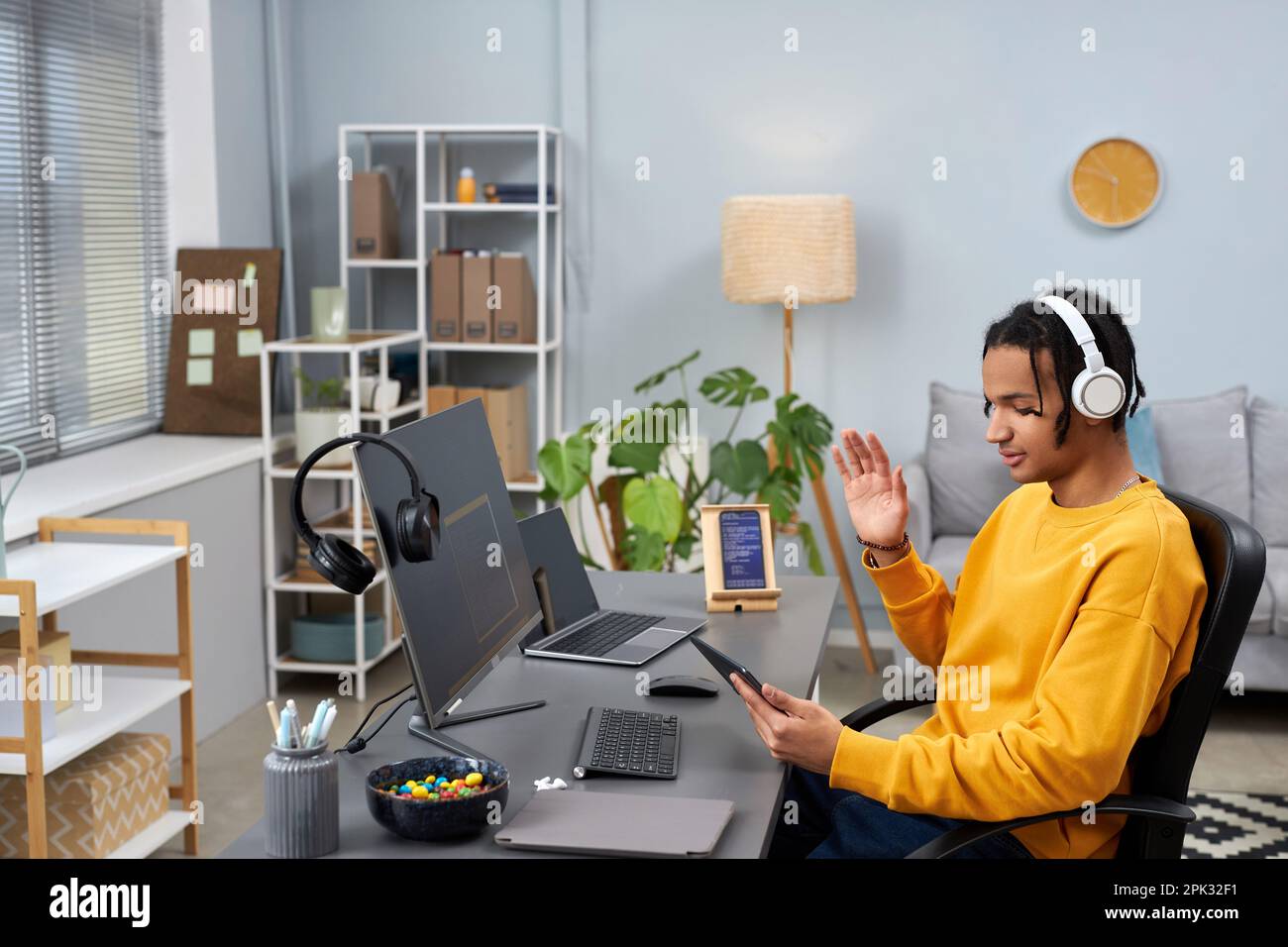 Side view portrait of black young man as software developer using video ...