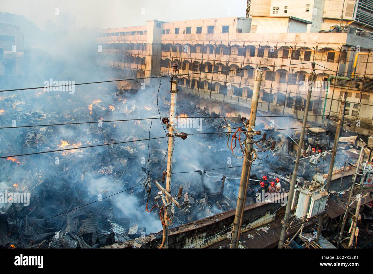 Firefighters work to control a major fire at the Bangabazar Shopping ...