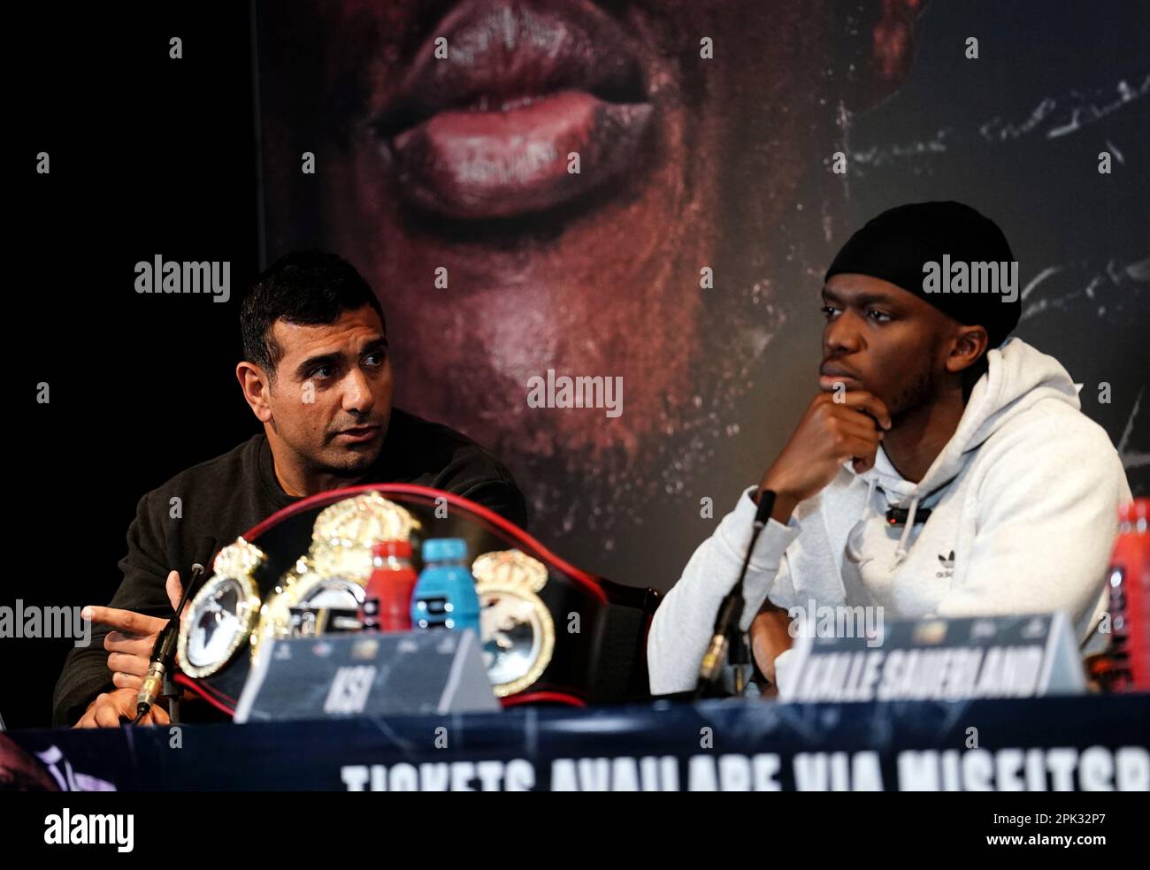 Trainer, Alexis Demetriades sits alongside KSI (right) during a press ...
