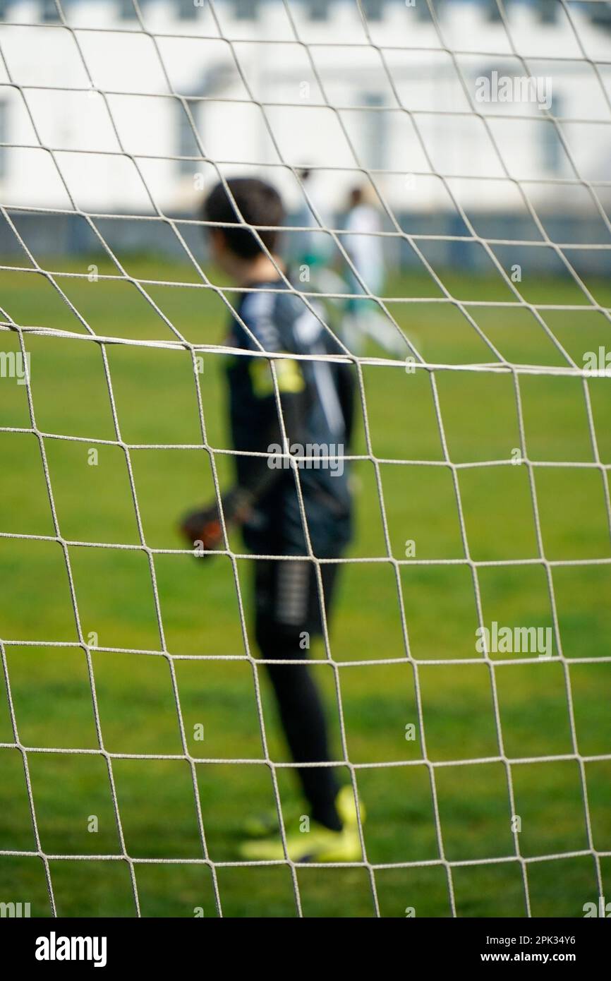 Youth team goalkeepers with the goal net in the foreground Stock Photo ...