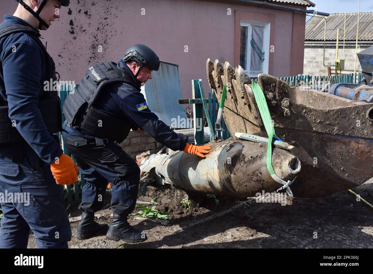 Ukrainian State Emergency Service workers remove a FAB-500 unexploded ...