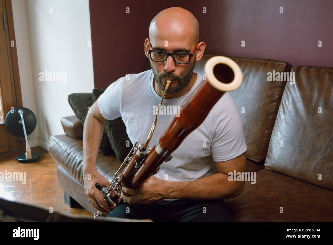 front view of young classical music composer man, with beard, glasses ...