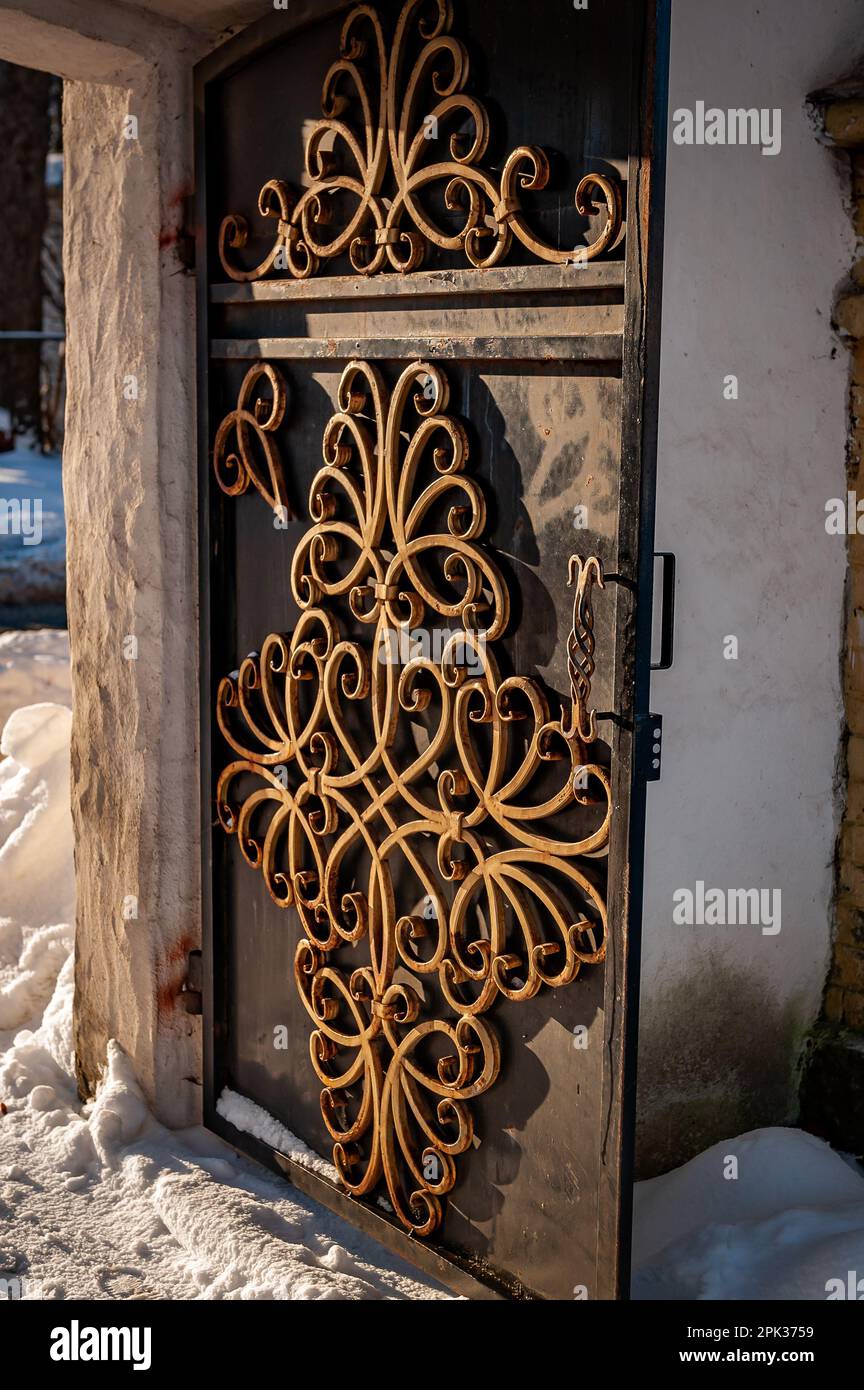 Open metal door in stone wall Stock Photo - Alamy