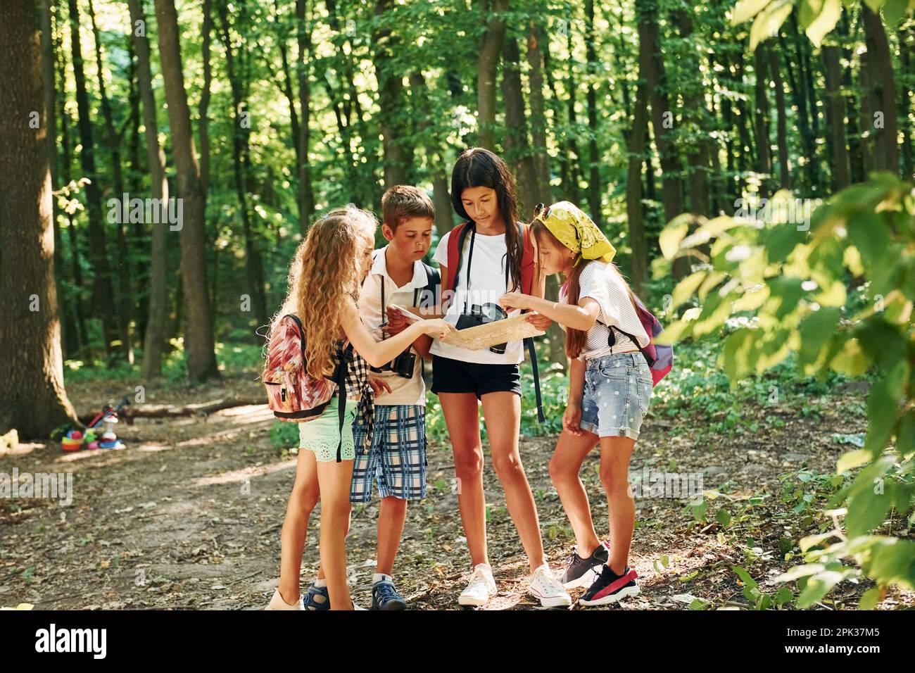 Kids strolling in the forest with travel equipment Stock Photo - Alamy
