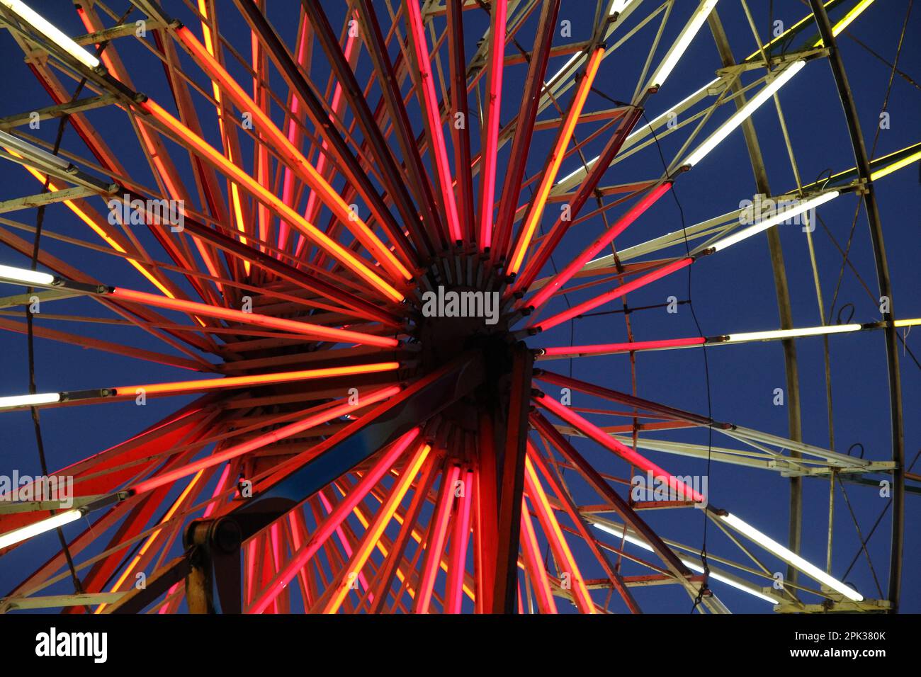 Close-up of Ferris Wheel at Night with Spokes of Neon Lights Stock Photo - Alamy