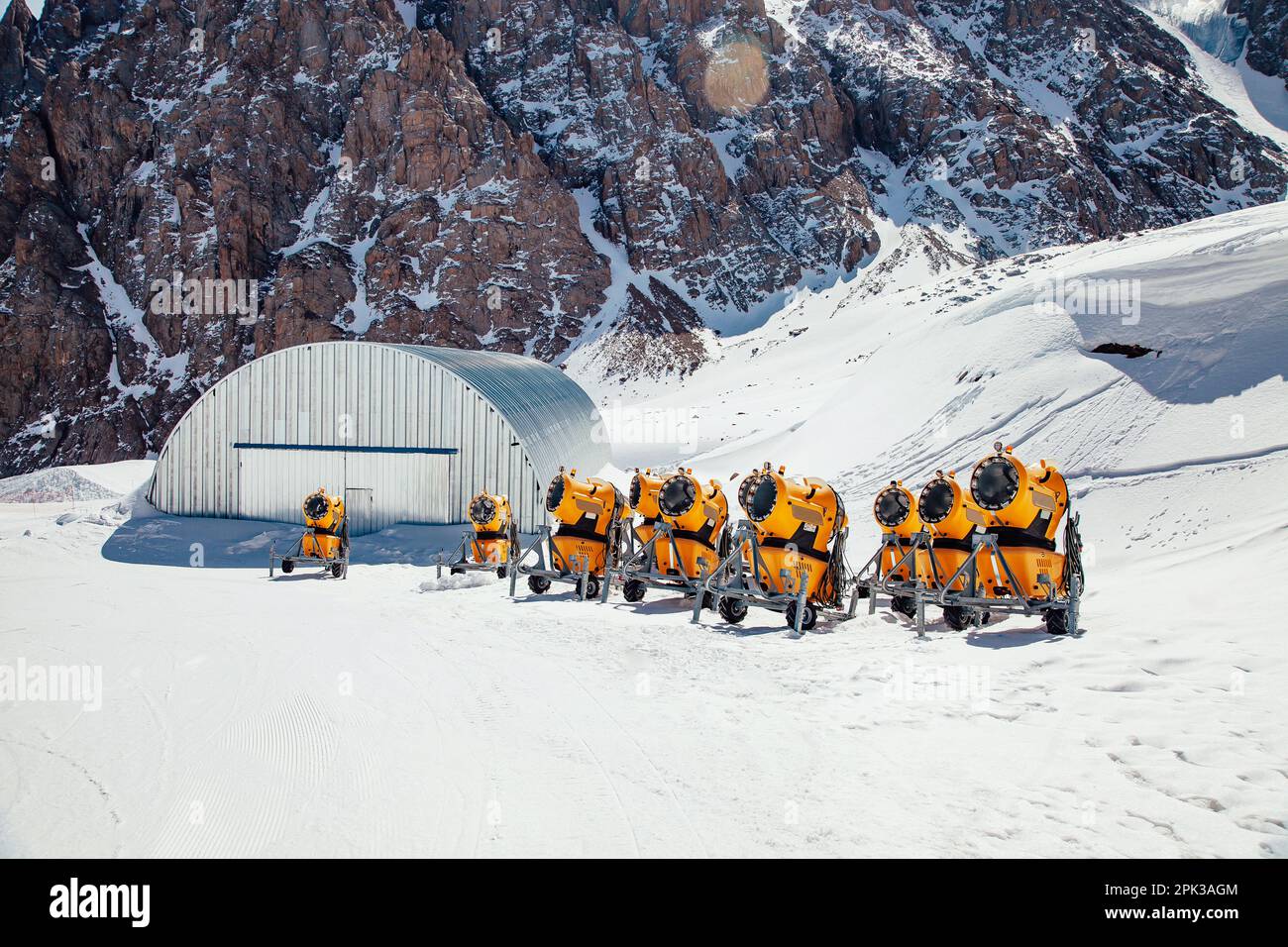 Group of yellow snow cannons are waiting for the start of the ski ...