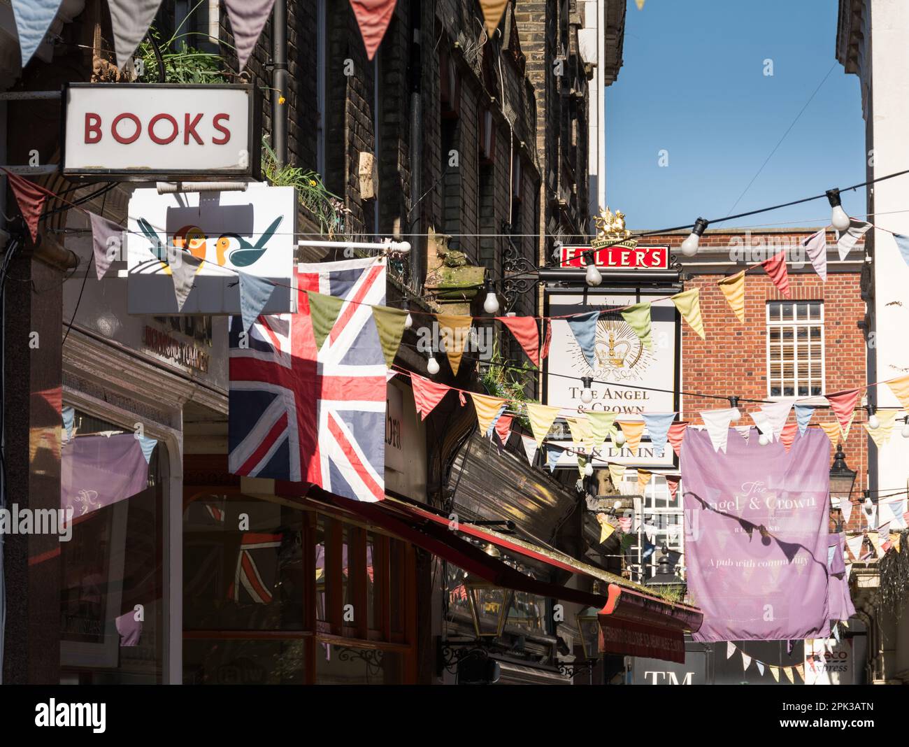 Closeup of colourful bunting and Angel & Crown pub sign on Church Court ...