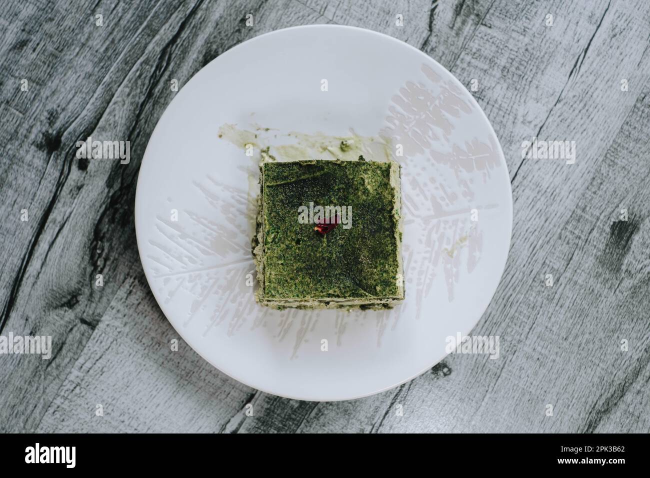 Flat lay shot or top view of Japanese Matcha Cake on a white plate ...