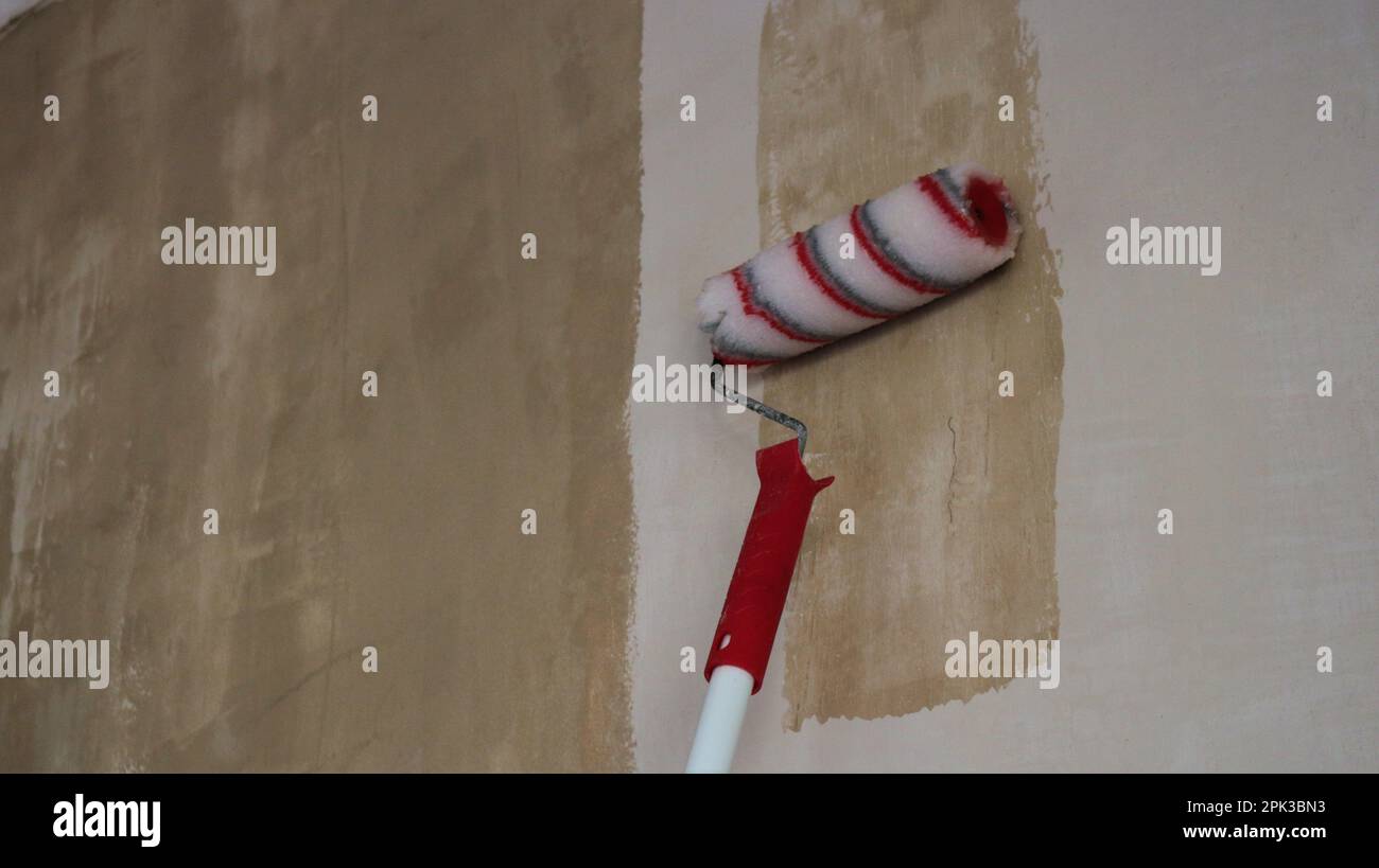 close-up of a striped red and white roller for applying glue, putty or ...