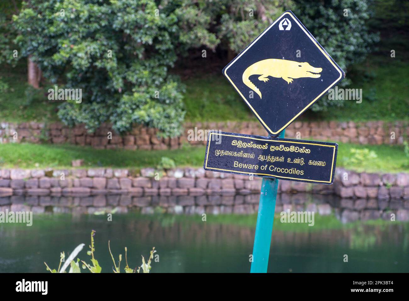 A sign warning of crocodiles in the water at Sigiriya in Sri Lanka ...