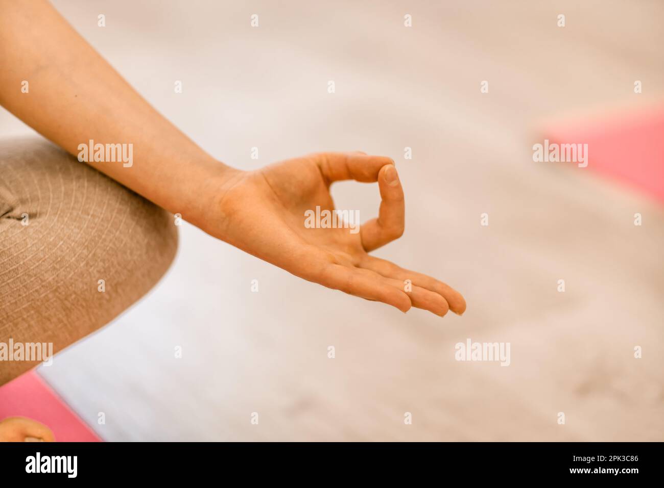 Girl does yoga. Young woman practices asanas on a beige one-ton ...