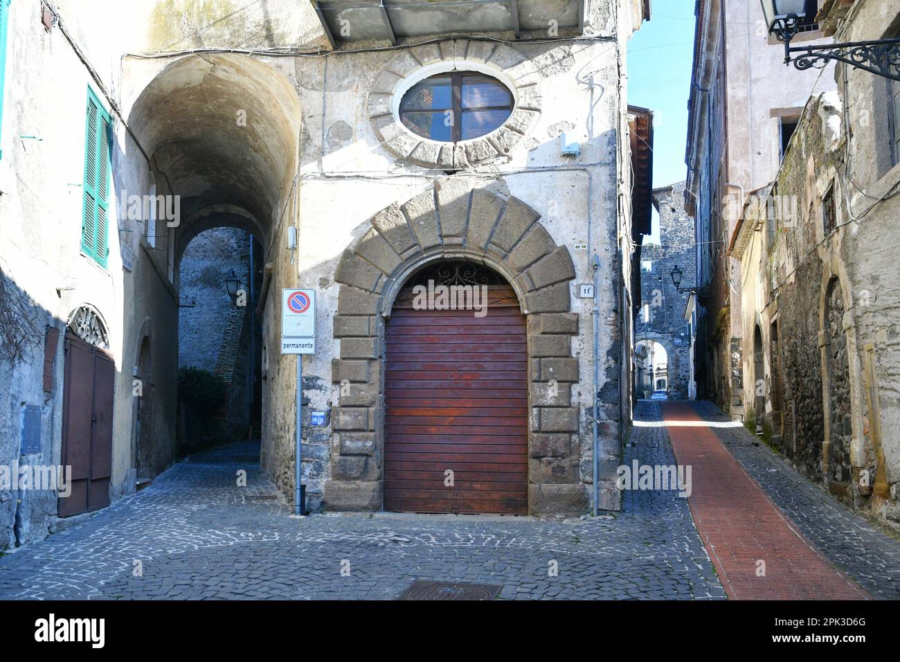 A narrow street among the old houses of Pofi, a medieval town in the ...