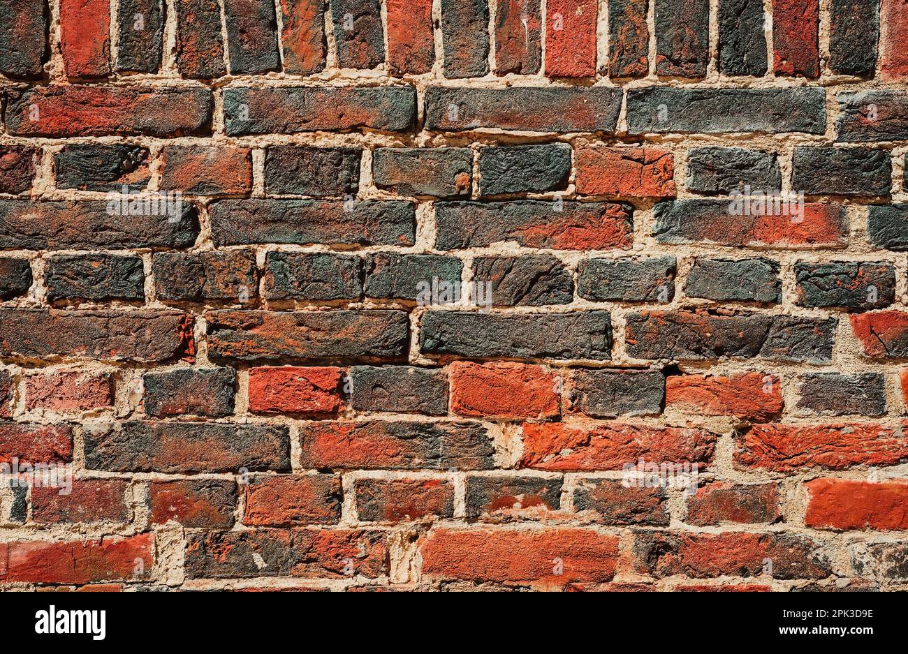 The texture of the wall of red and black burnt bricks in high ...