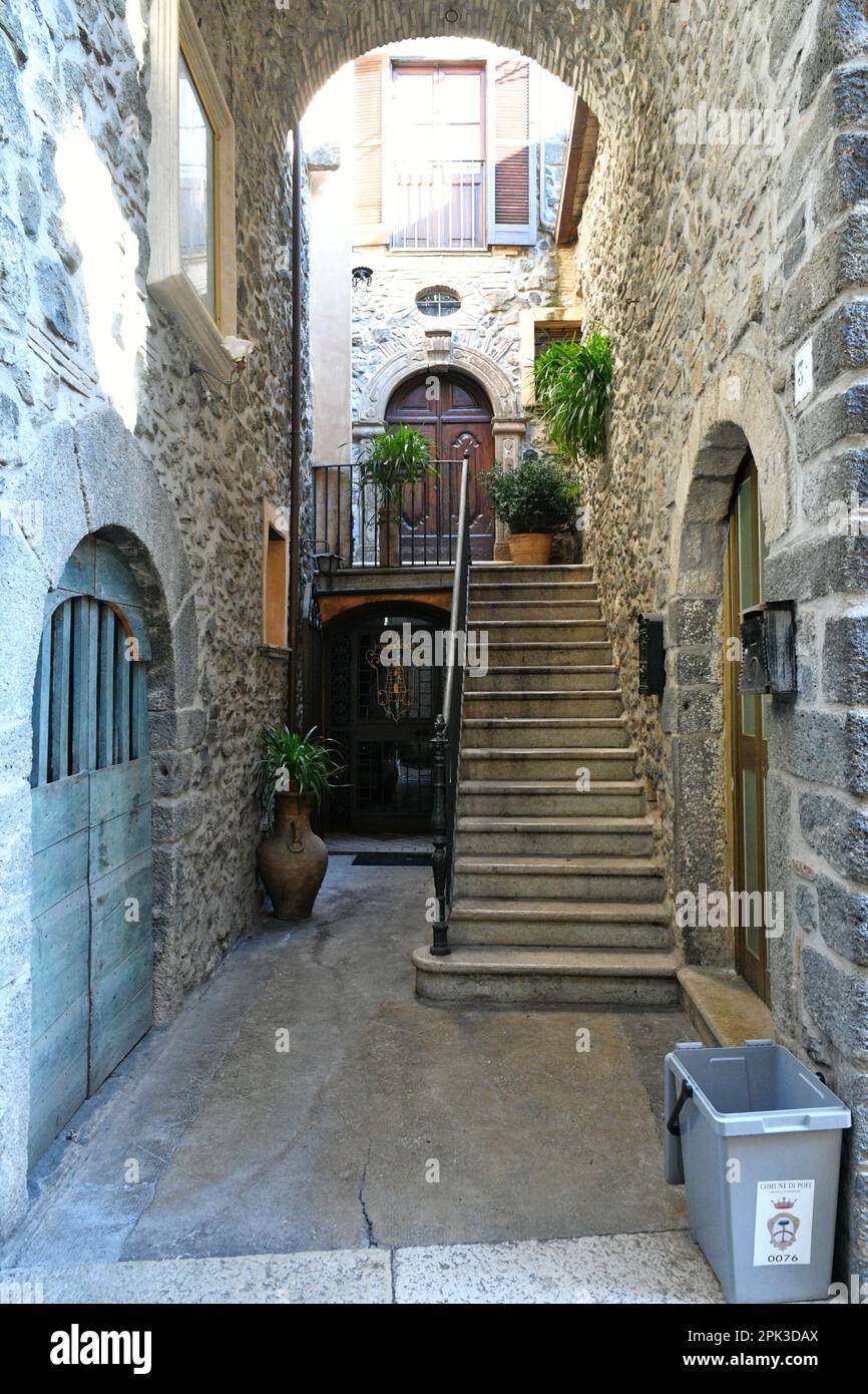 A narrow street among the old houses of Pofi, a medieval town in the ...