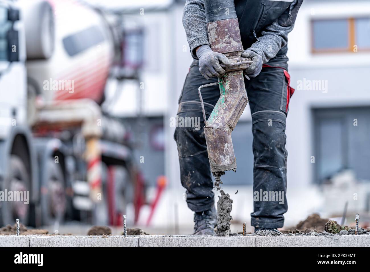 concreting from the pipe of the cement mixing car Stock Photo - Alamy