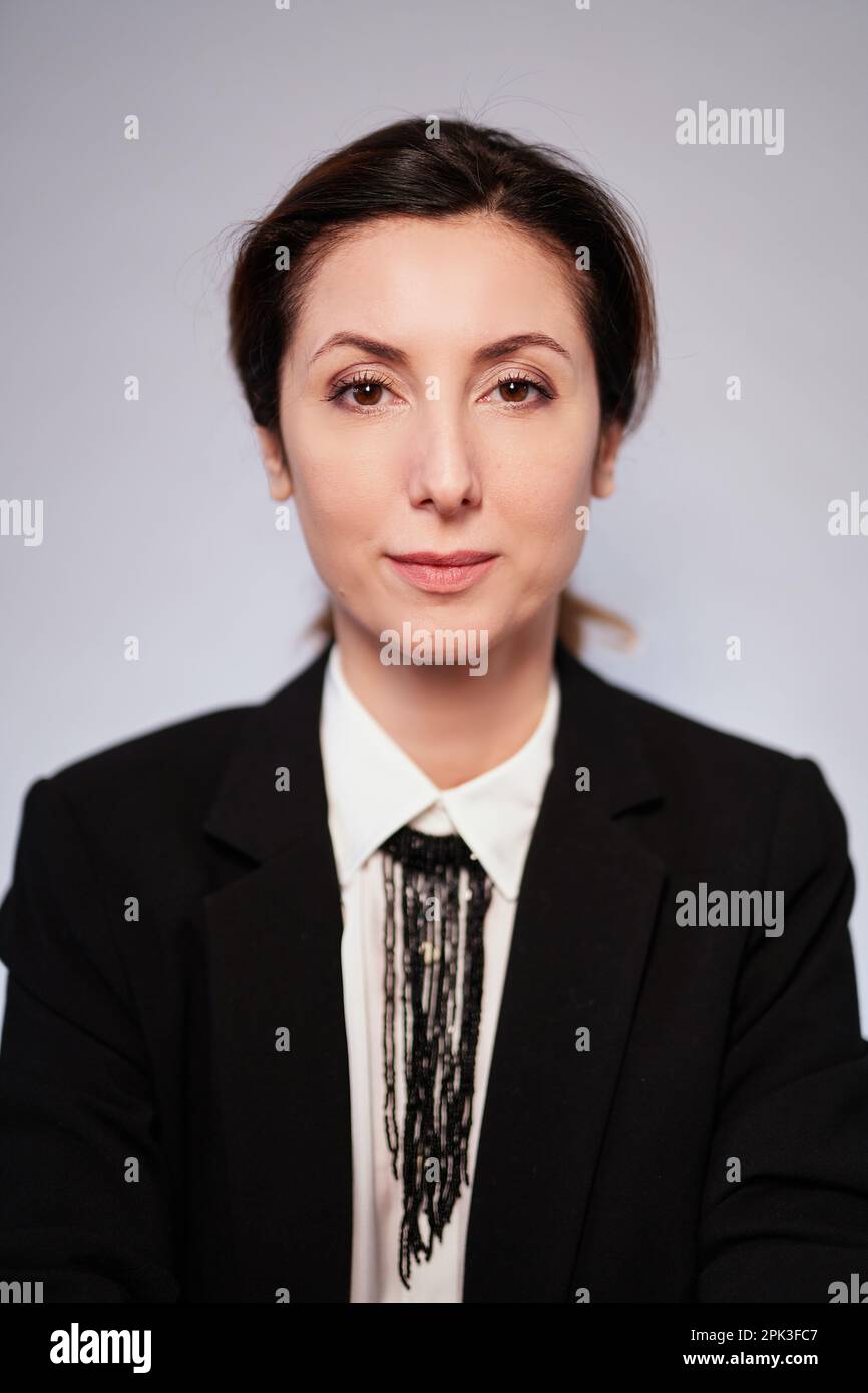 Cheerful manager woman portrait in dark suit laughing and looking at ...