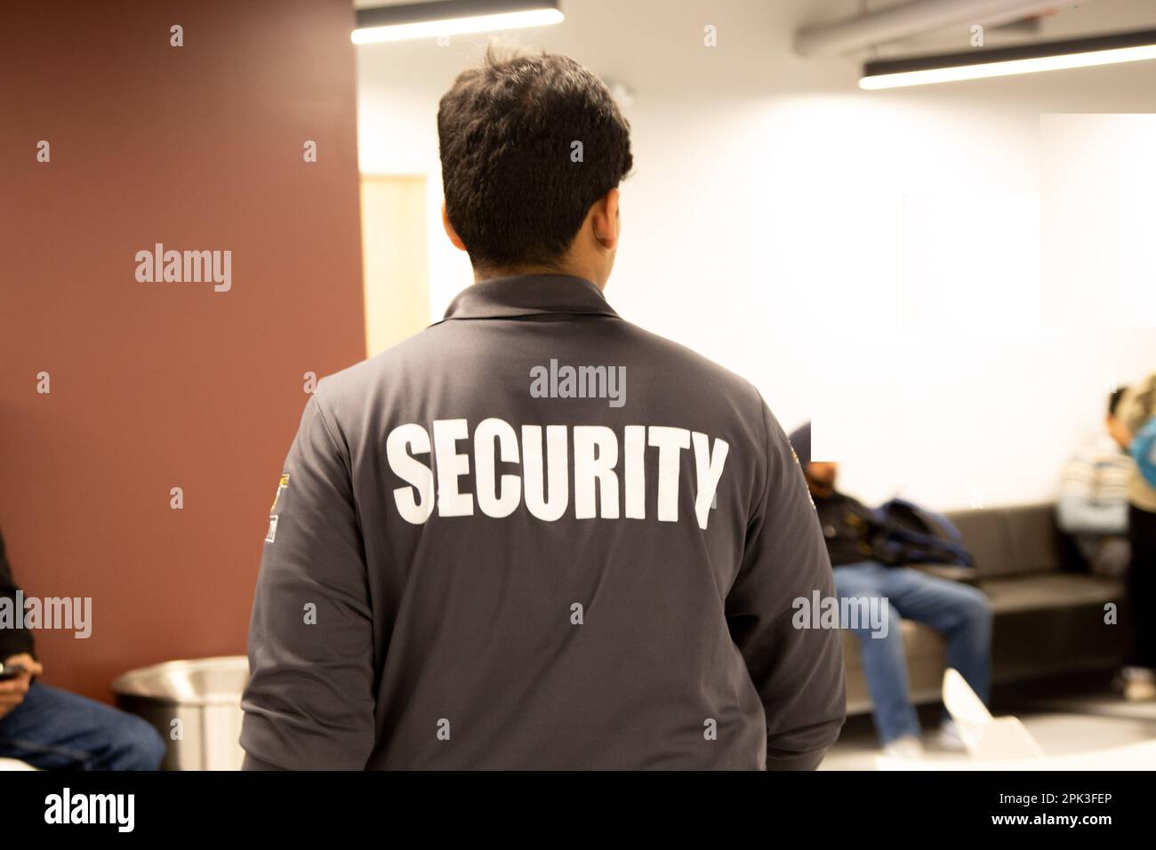 Security guard patrolling office space Stock Photo - Alamy