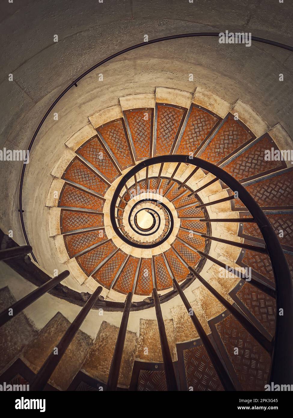 Circular staircase with black metal railing, inside the triumphal arch ...