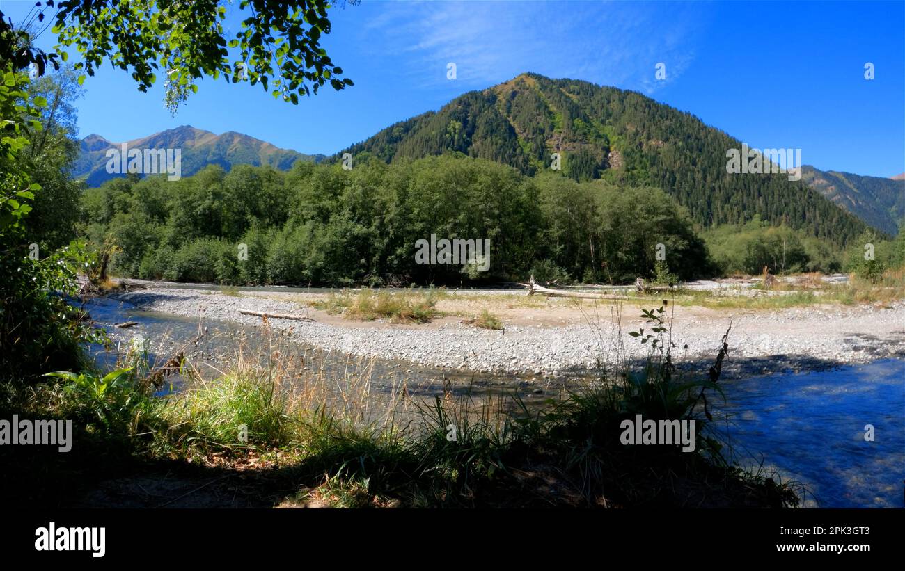 tiny clear cold stream with pebble rocks in Arkhyz mountain ridge ...