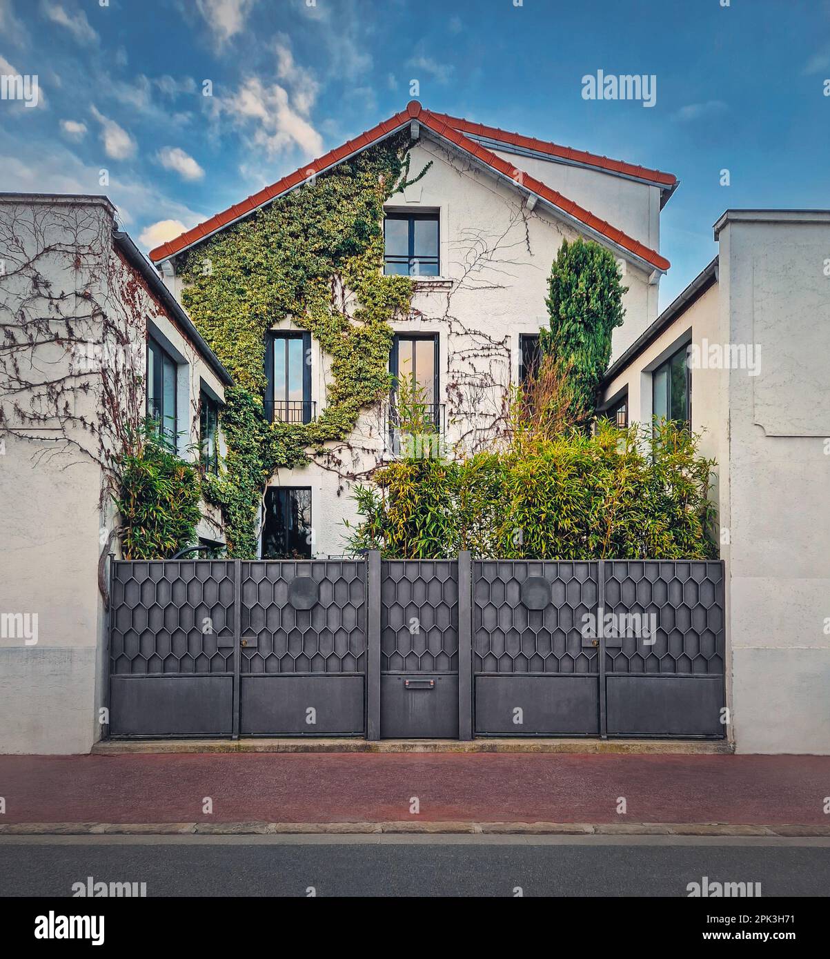 Green eco friendly home. House facade with different plants and trees ...