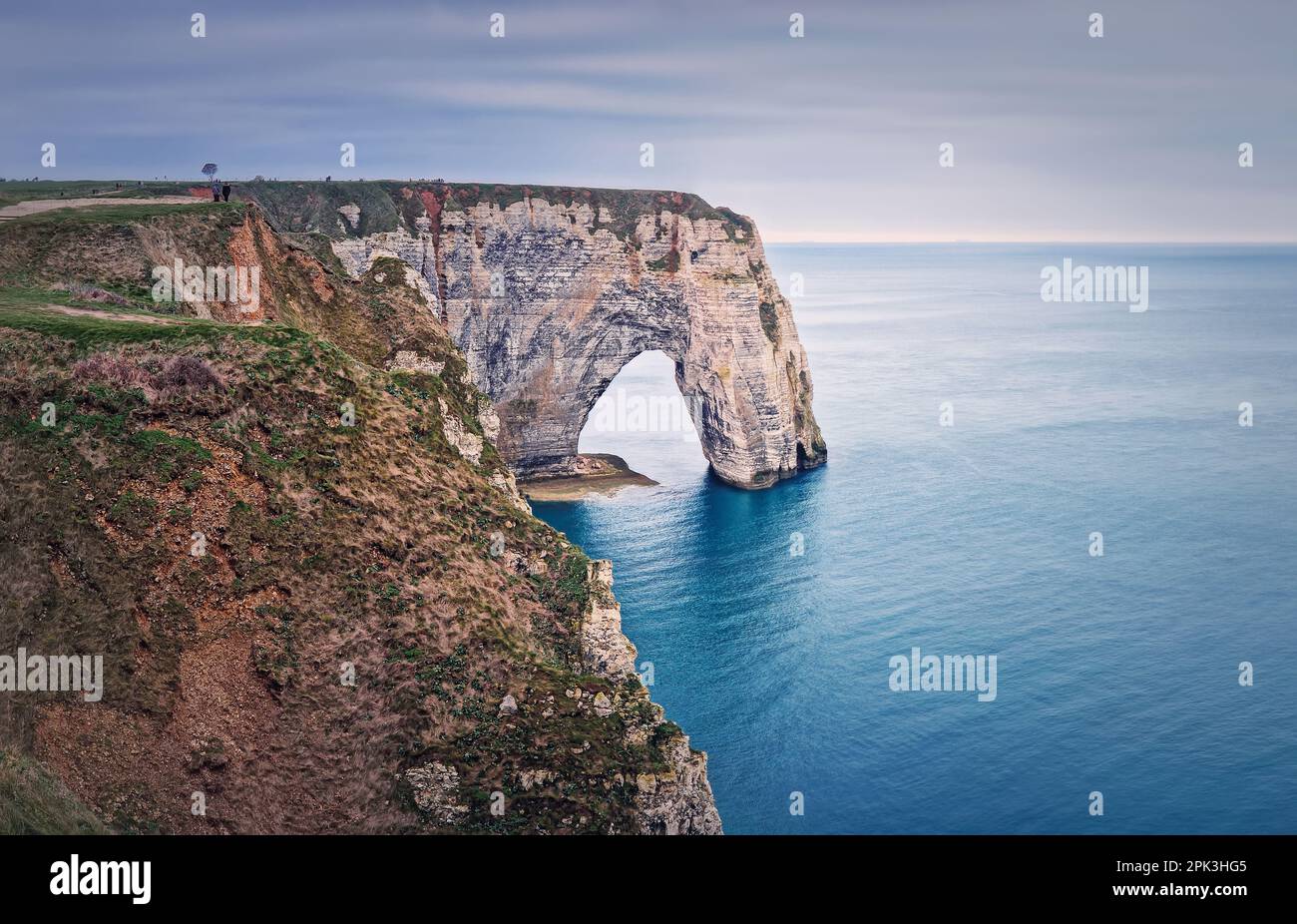 Sightseeing view to the Porte d'Aval natural arch cliff washed by ...