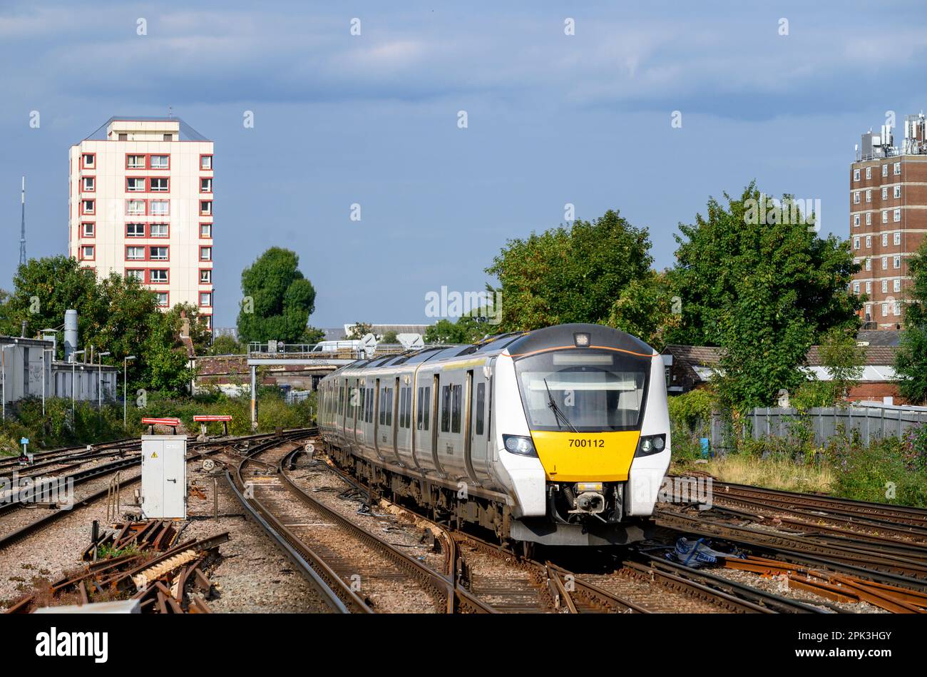 Class 700 passenger train in Thameslink livery travelling along track ...