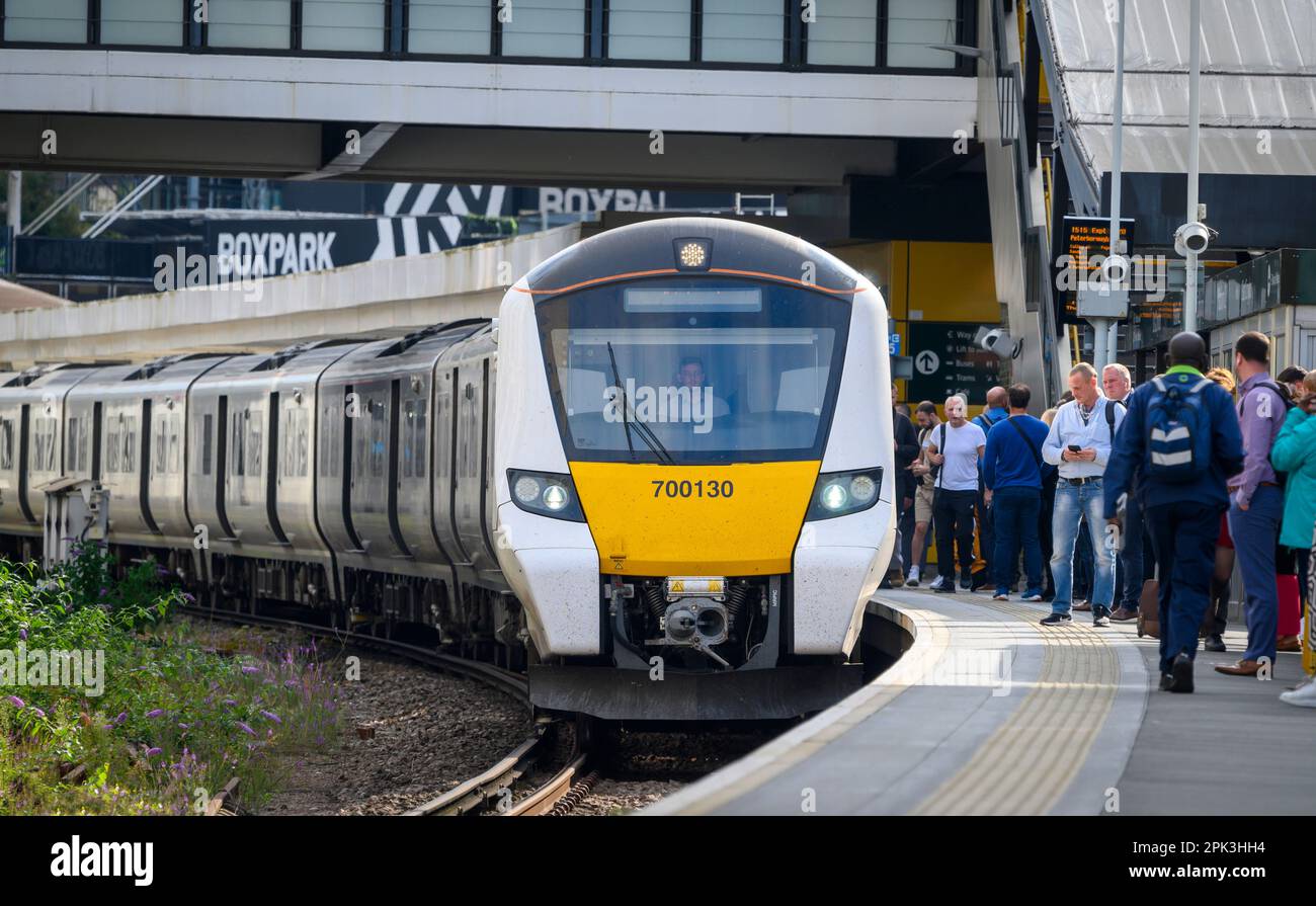 Class 700 passenger train in Thameslink livery arriving at a railway ...