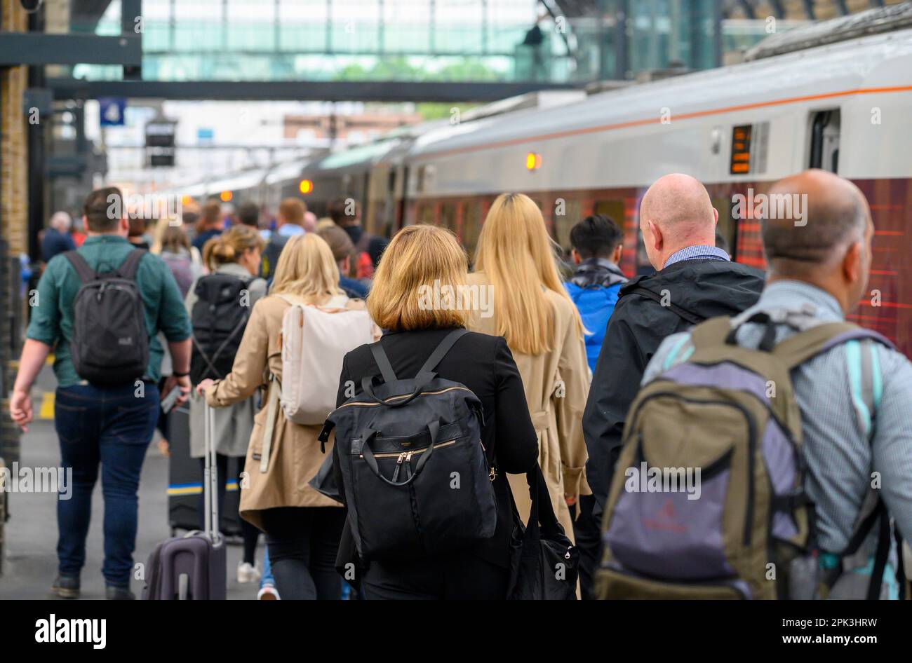 Crowded platform at a railway station during rush hour, England Stock ...