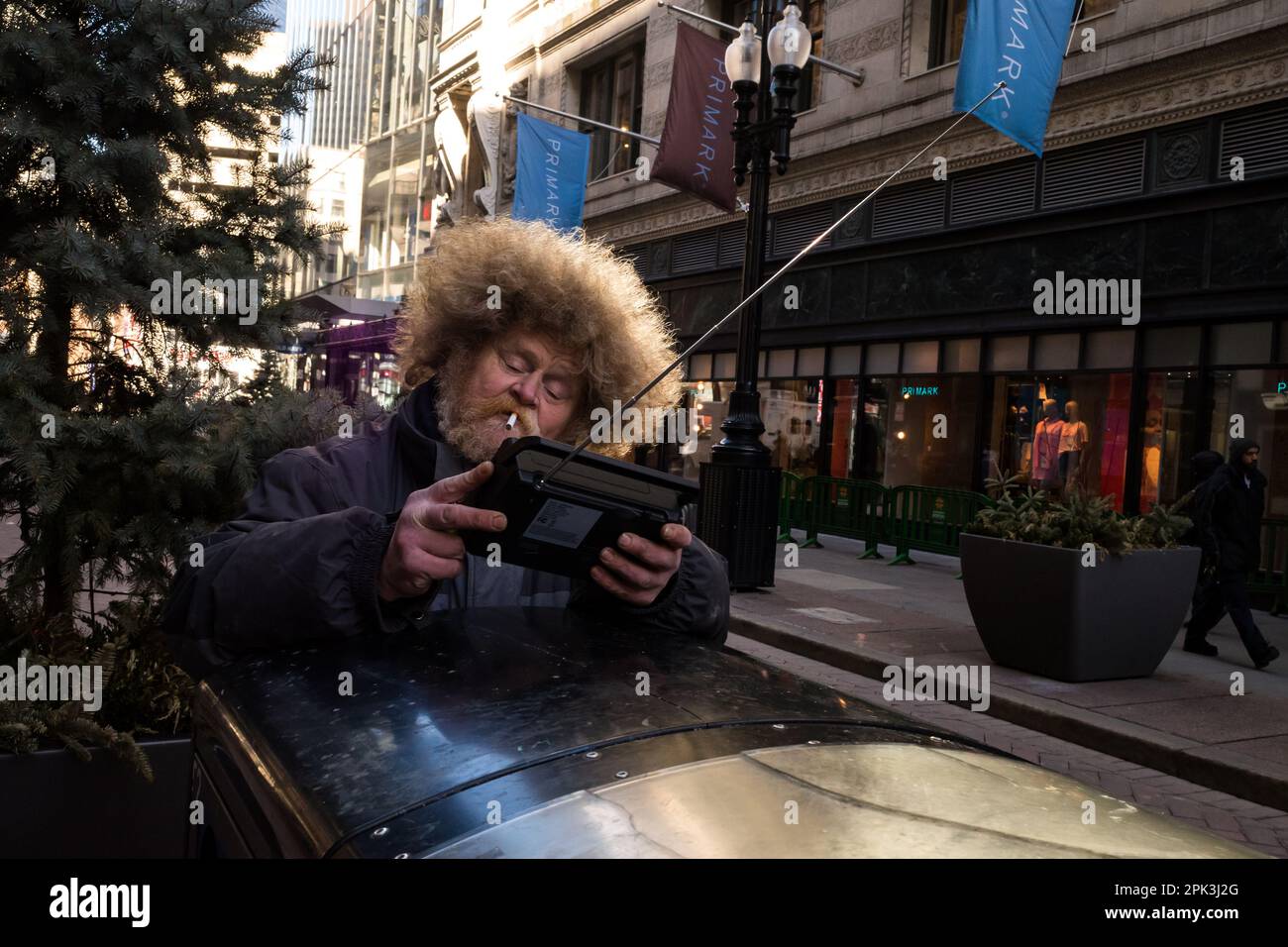 Boston, USA. 8 Mar, 2023. A man smoking a cigarette on a sidewalk with ...