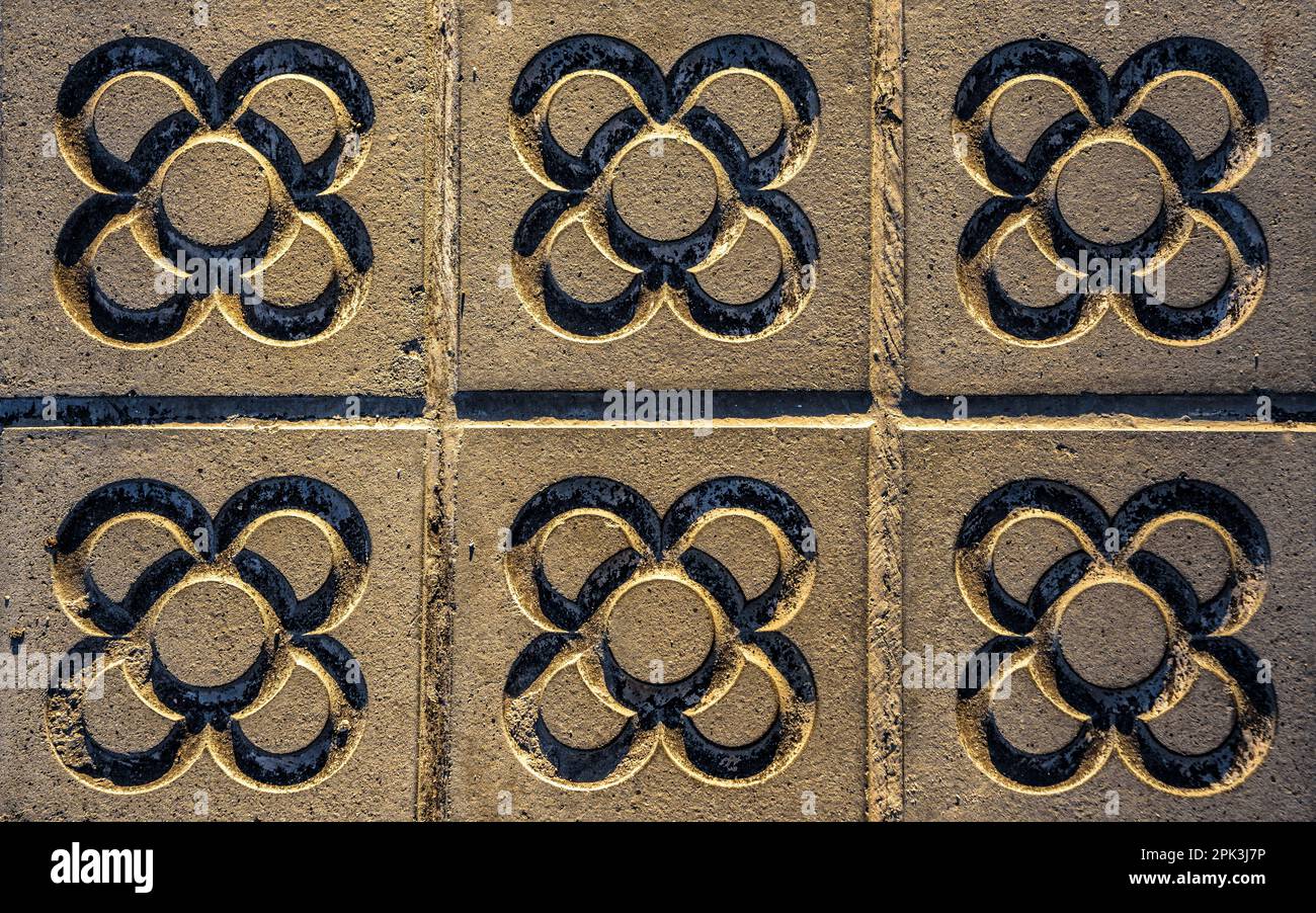 Detail of the tile "Flor de Barcelona" on a sidewalk at sunset ...