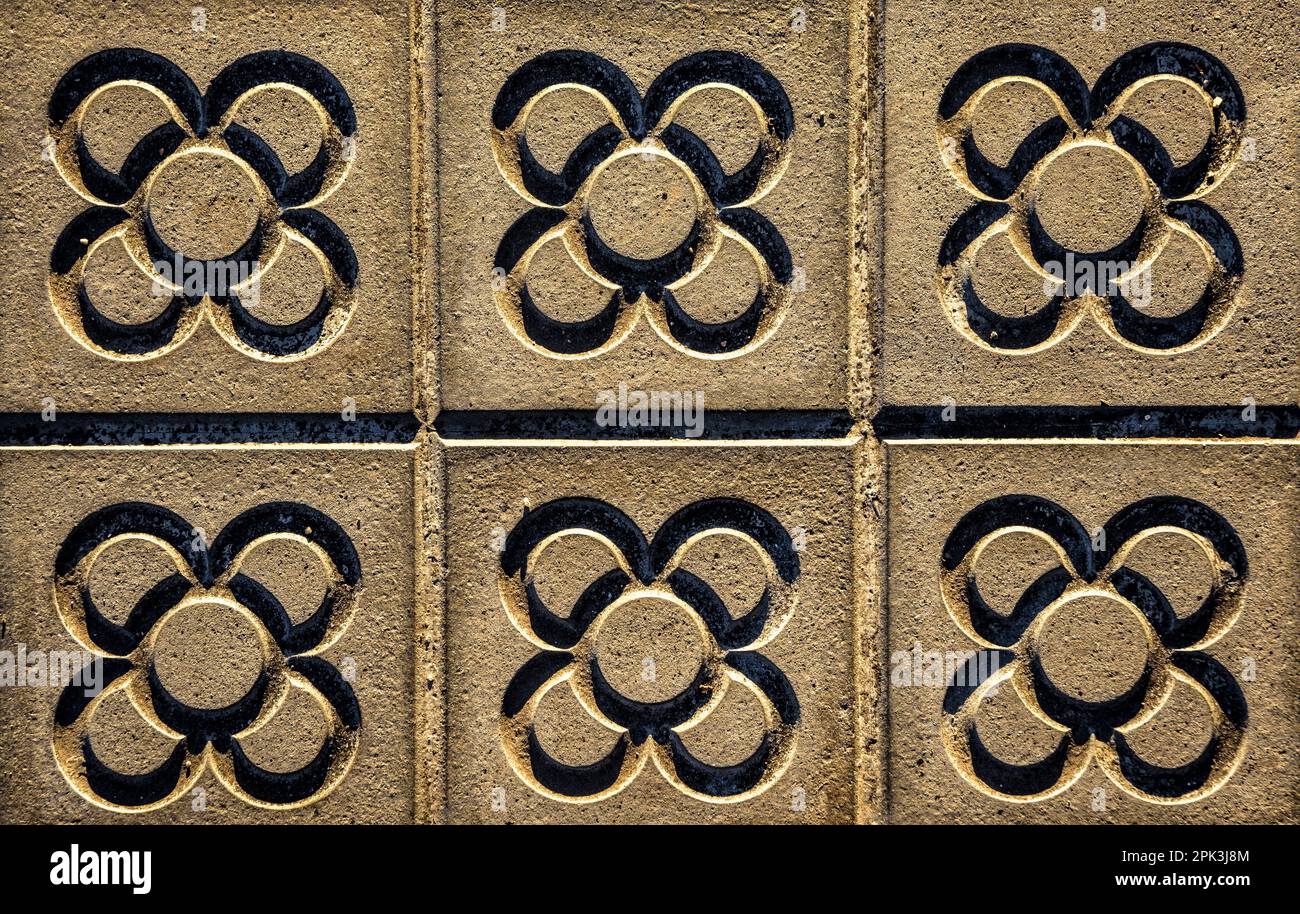 Detail of the tile "Flor de Barcelona" on a sidewalk at sunset ...