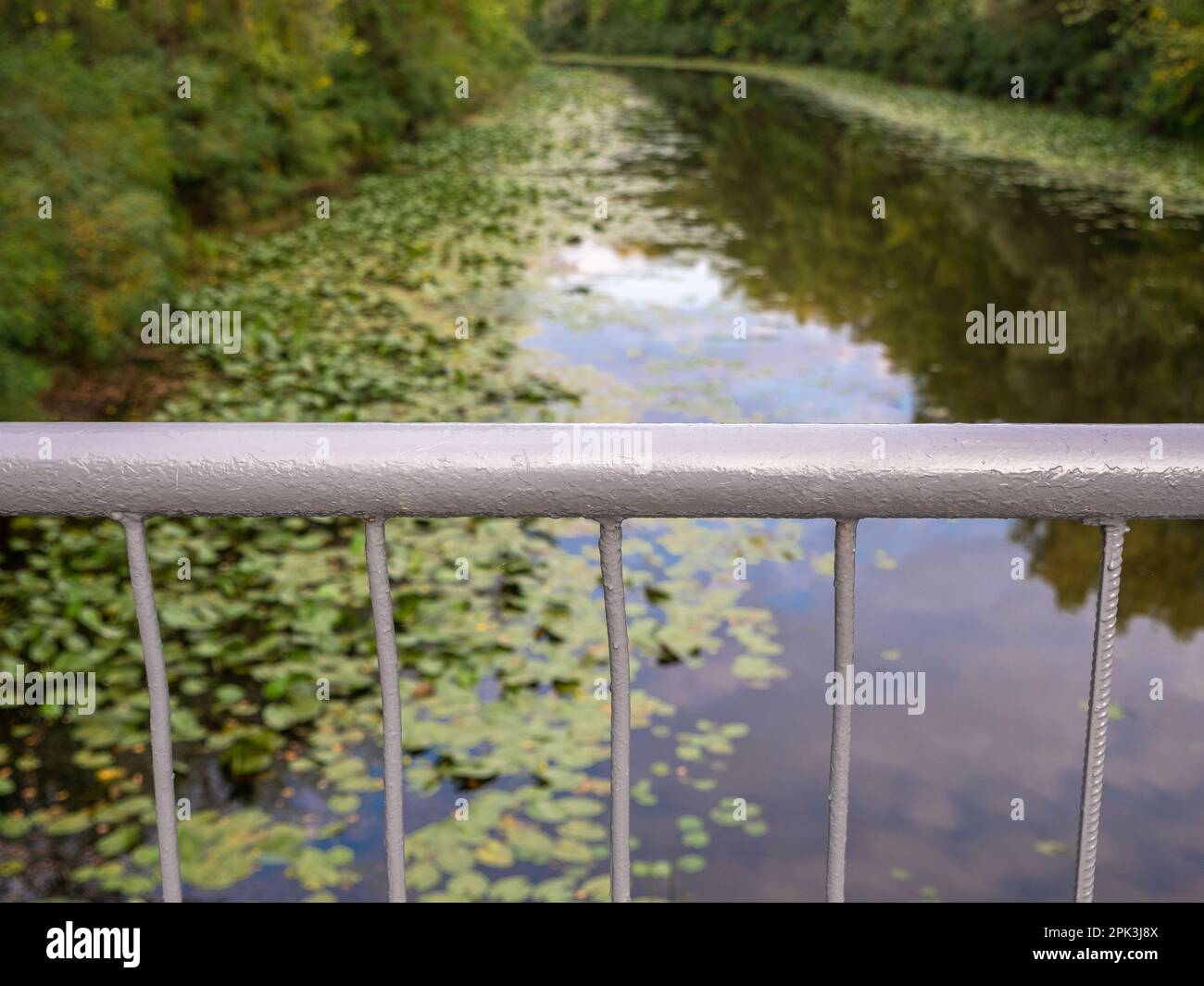 View down from the bridge painted metal railing over the narrow Dnipro ...