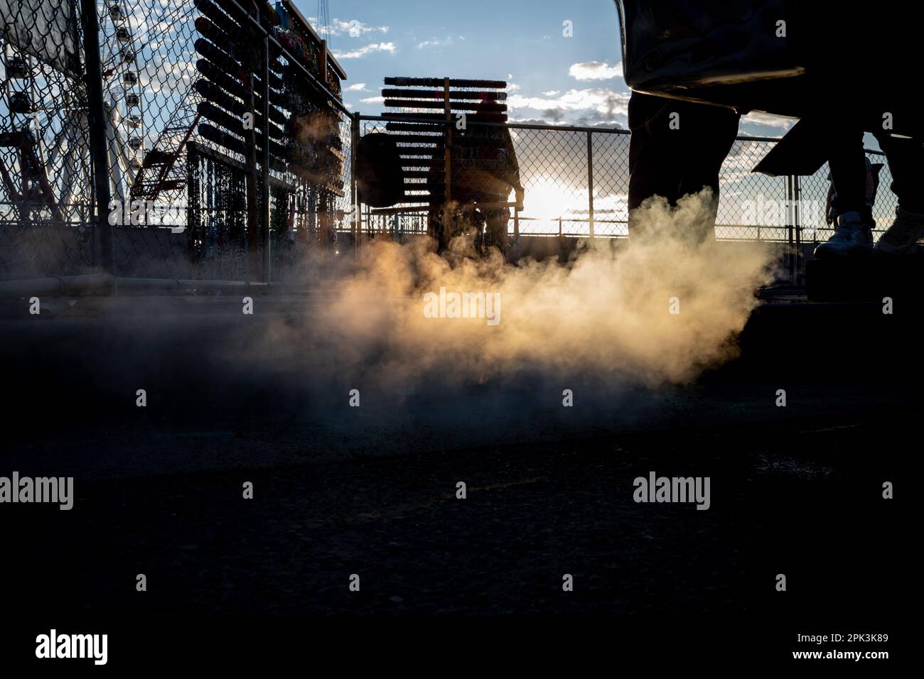 Seattle, USA. 22 Mar, 2023. Smoke coming out of a car exhaust at sunset ...