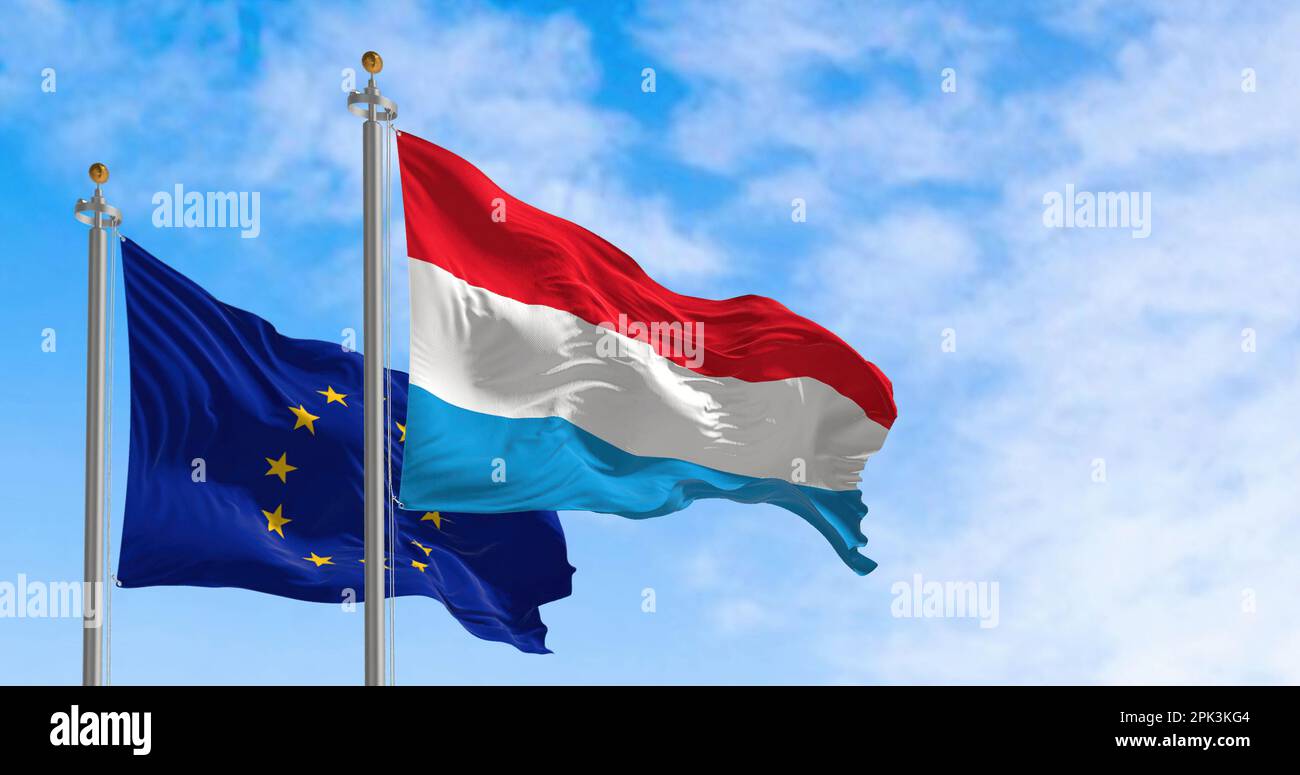 The flags of Luxembourg and the European Union waving in the wind on a ...