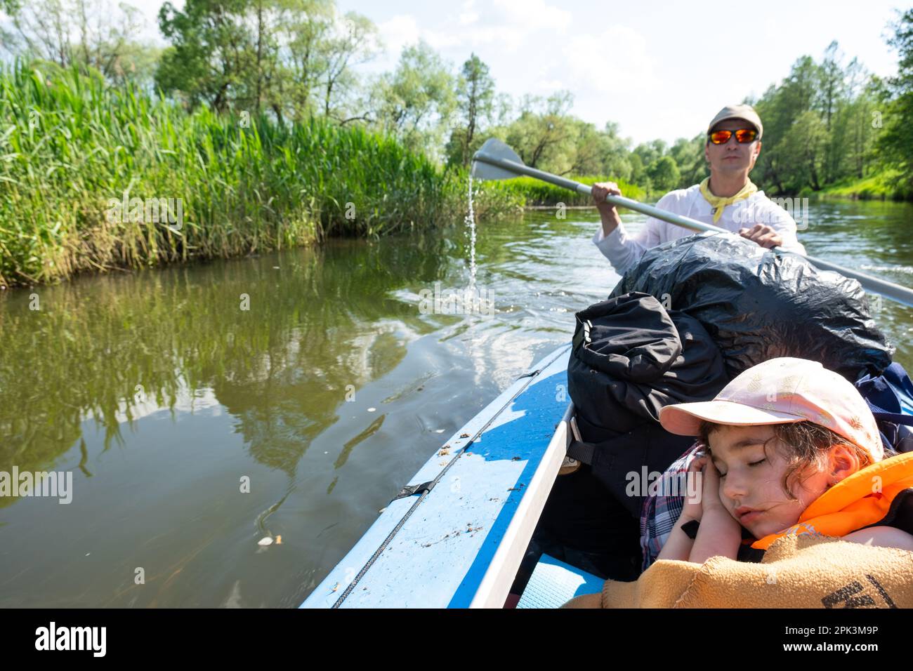 Family kayak trip. Father and daughter rowing boat on the river, a ...